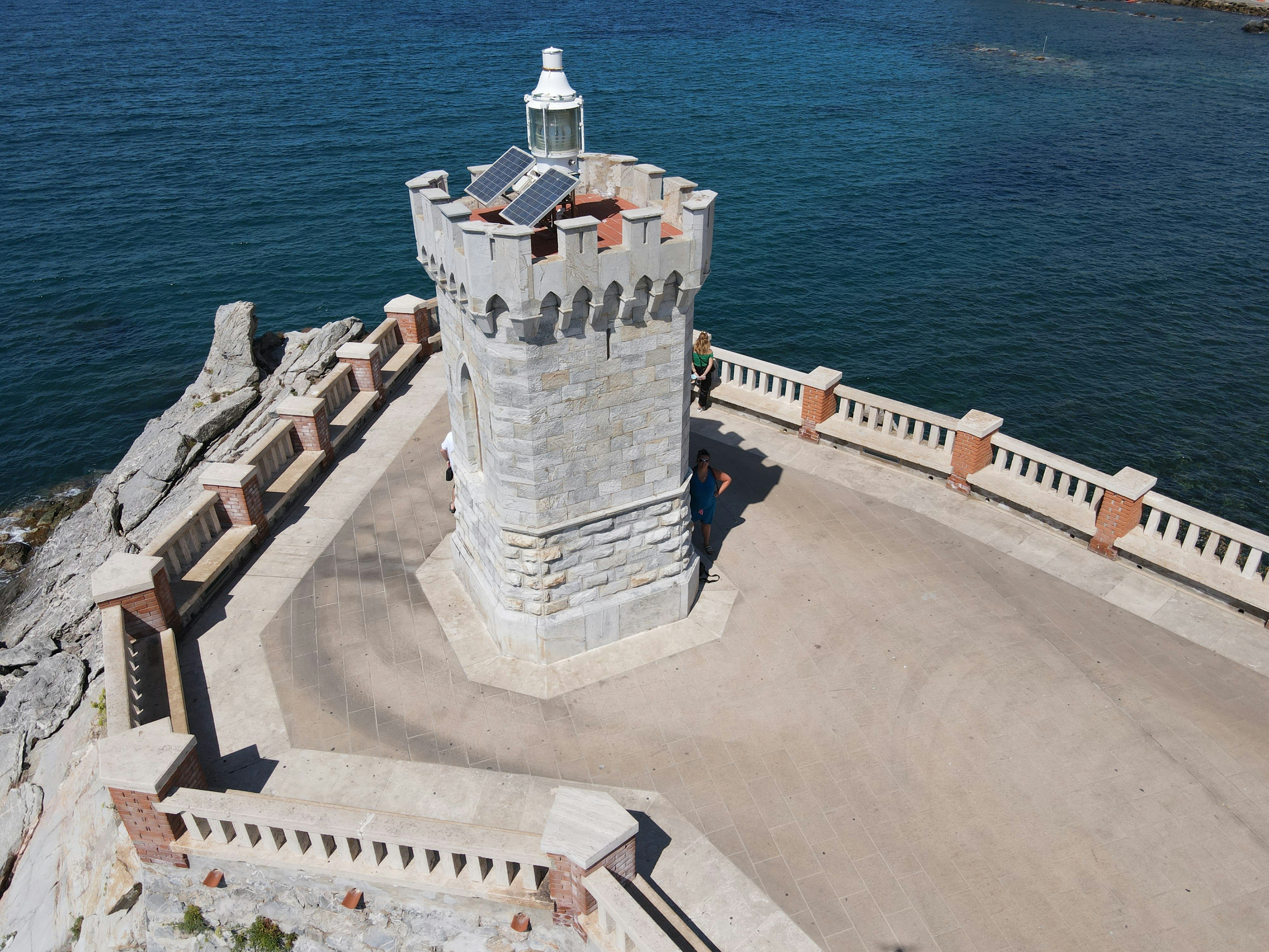 Harbor Sentinel: A Cliffside Stone Tower Over the Atlantic
