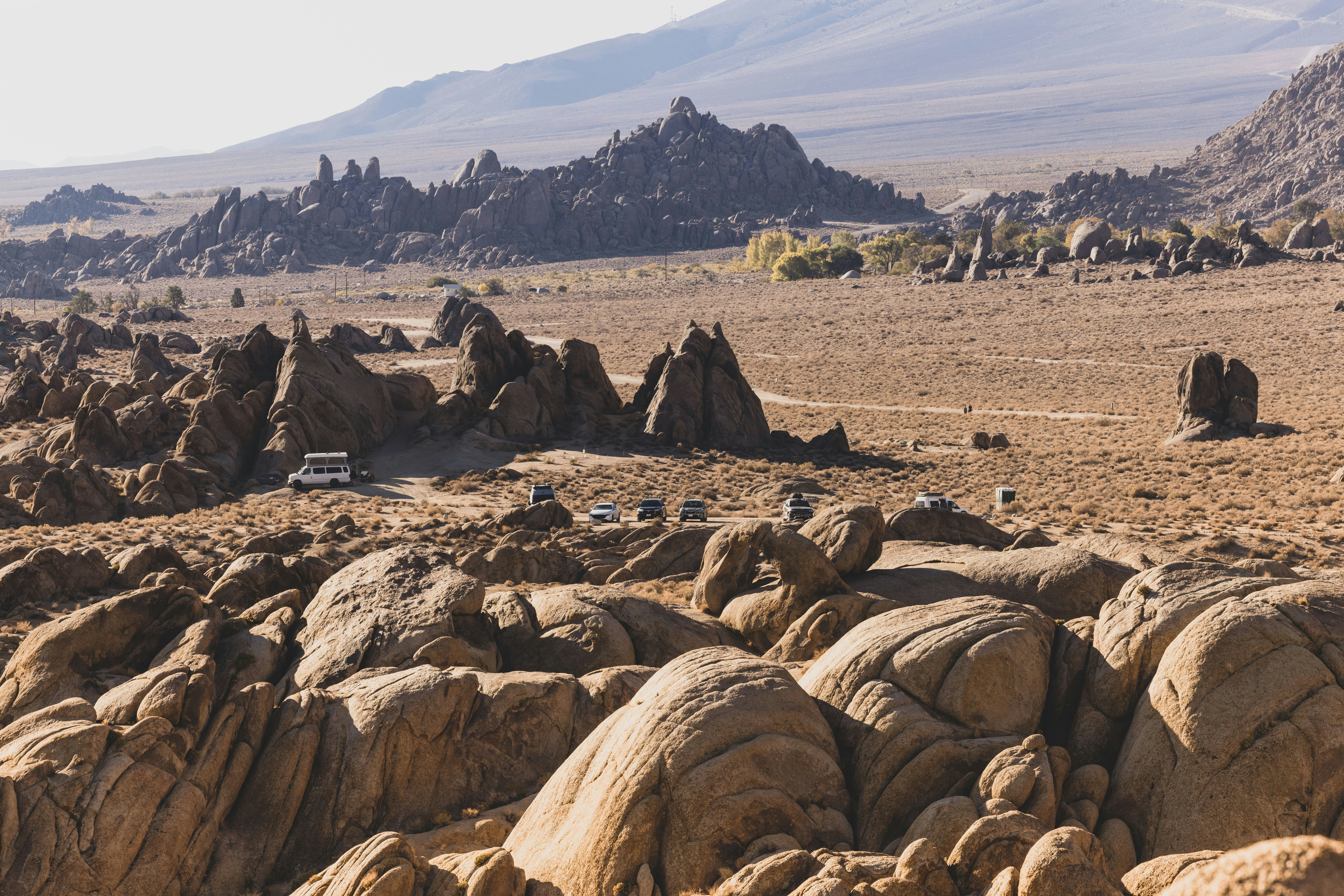 A desert landscape with rocks and mountains in the background photo ...