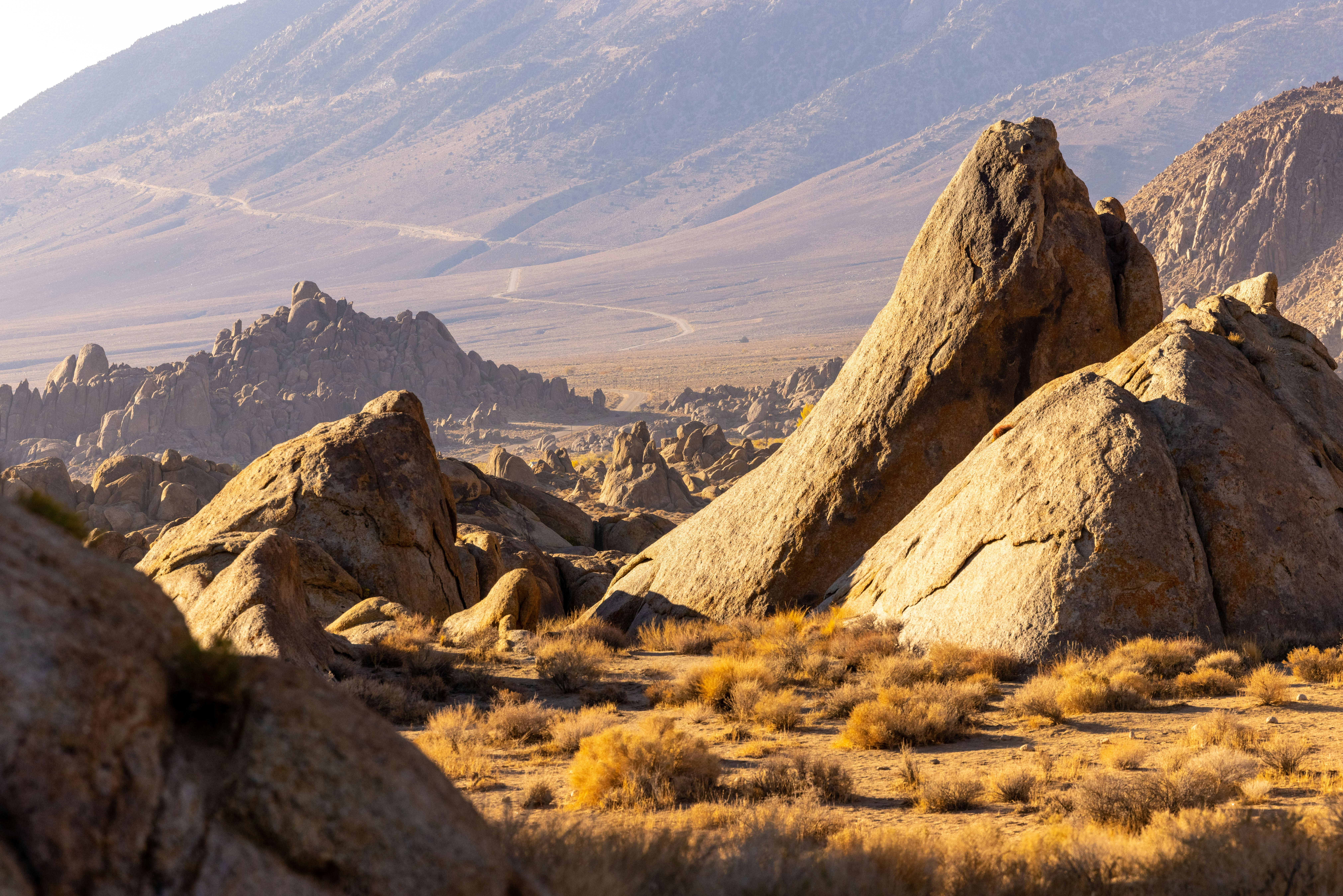 Large rocks in the desert with a mountain in the background photo ...