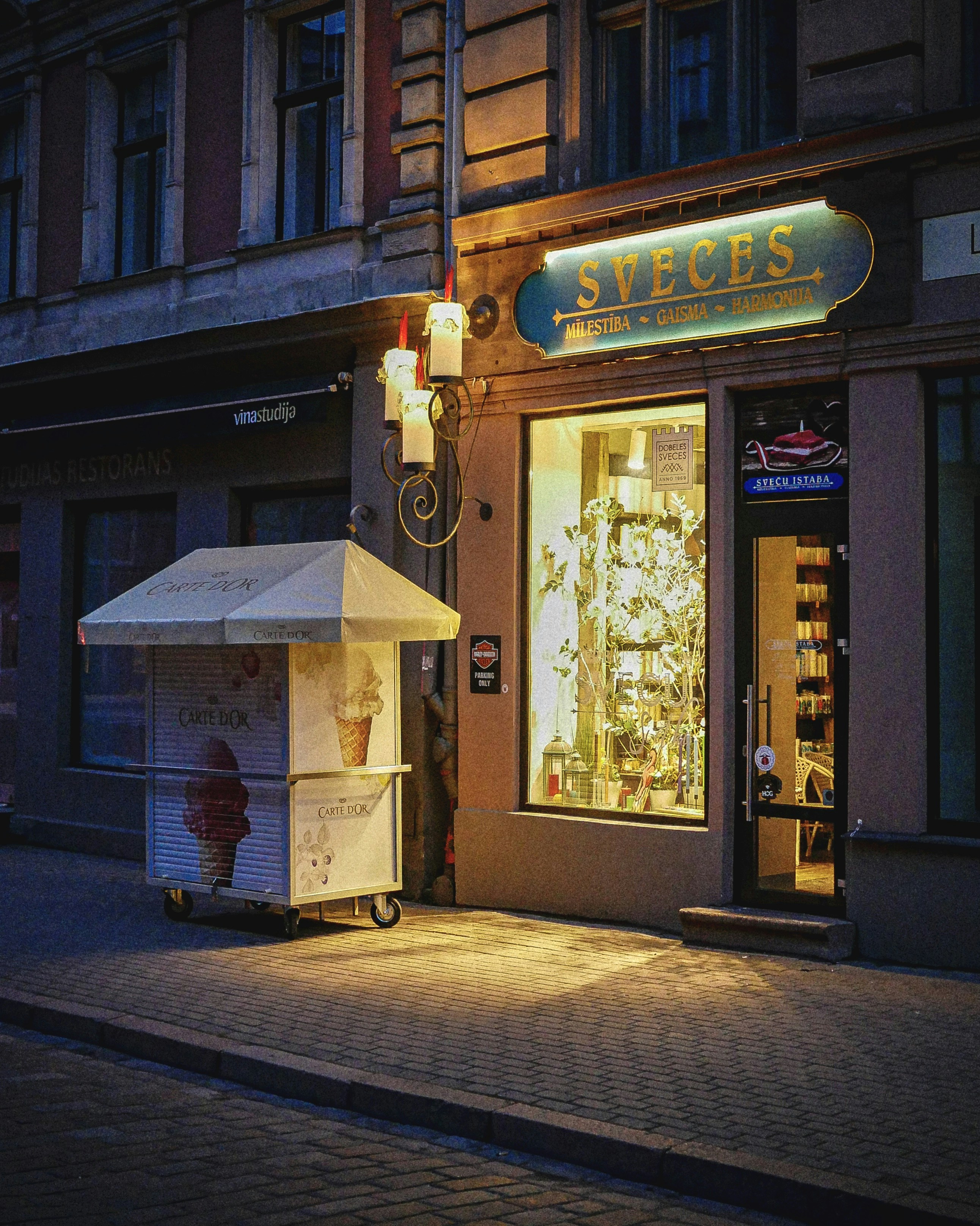 A storefront at night with a light on photo – Free Shop Image on Unsplash