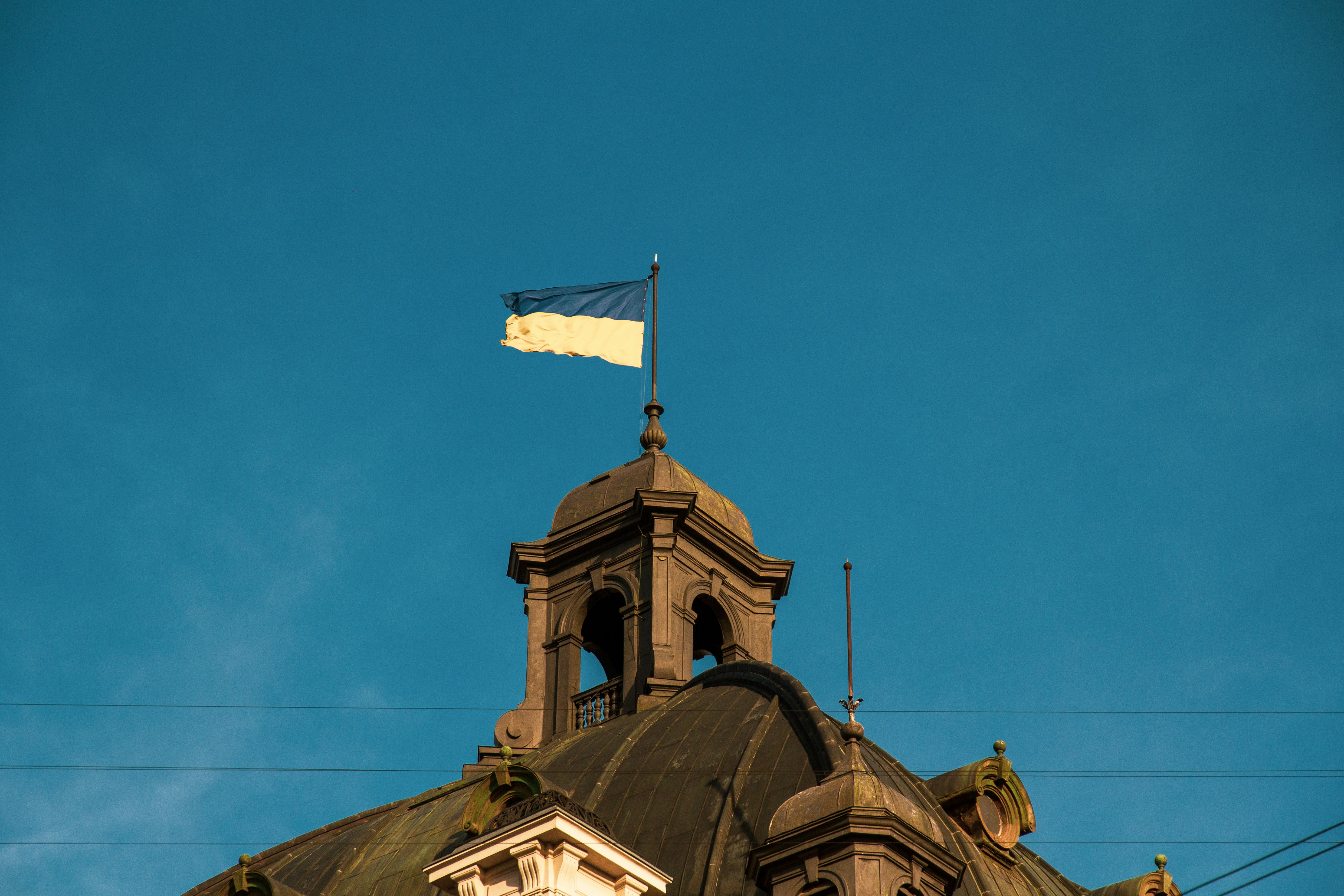 Flag-Topped Cupola Against a Cerulean Sky