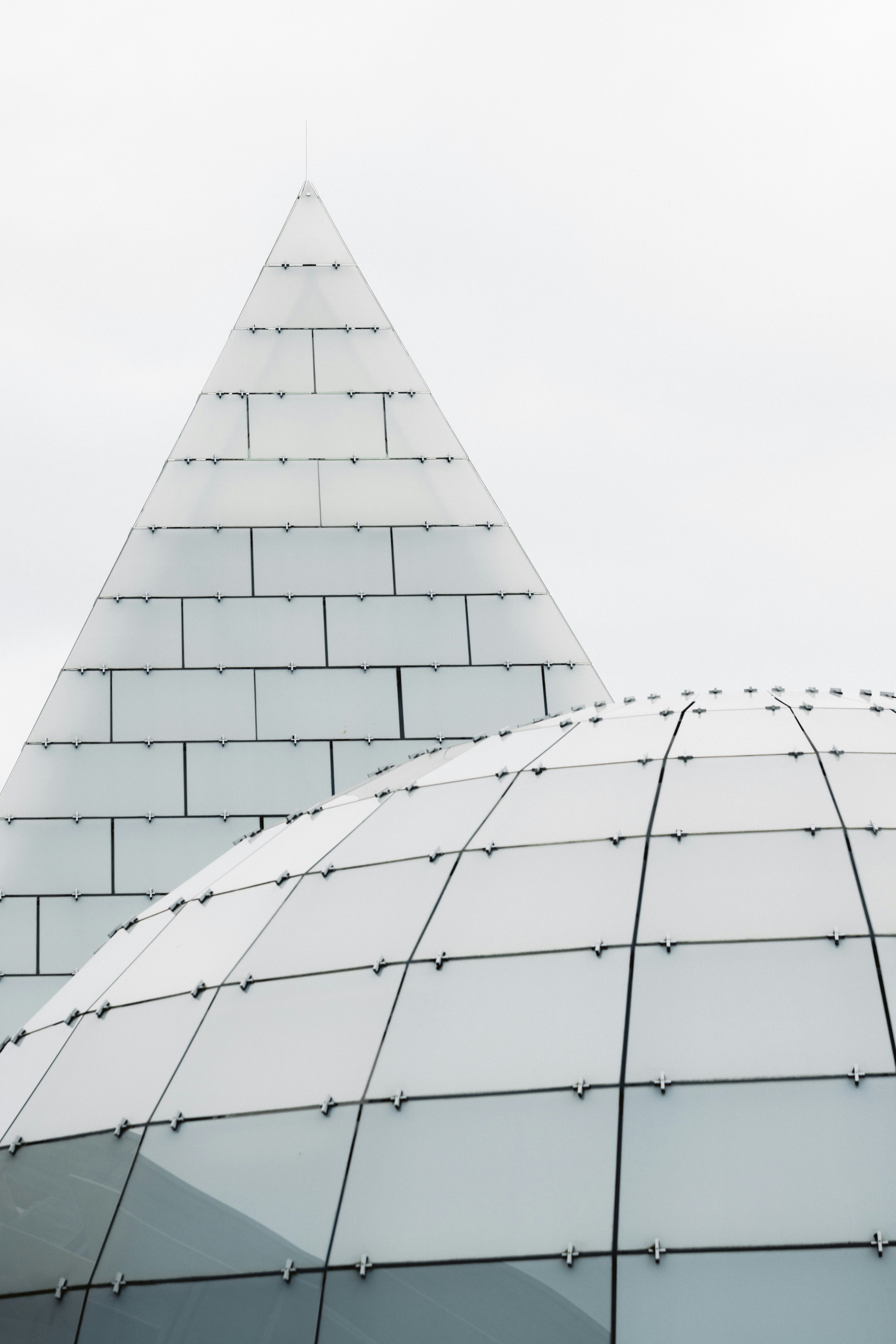 A close up of a building with a triangle shaped roof photo – Free Grey ...