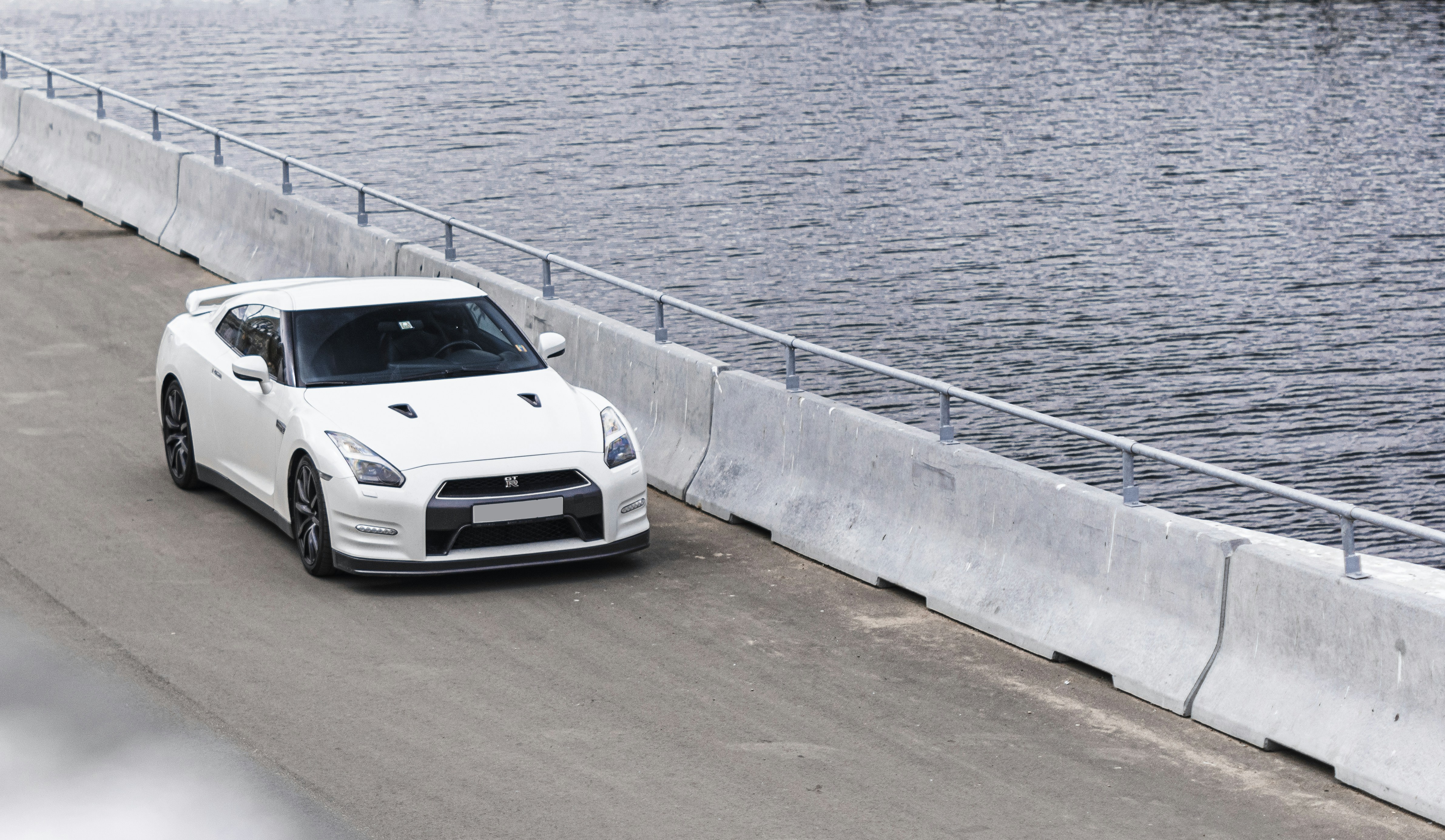 Harbor Run: White GT-R Cutting Along the Concrete Waterfront
