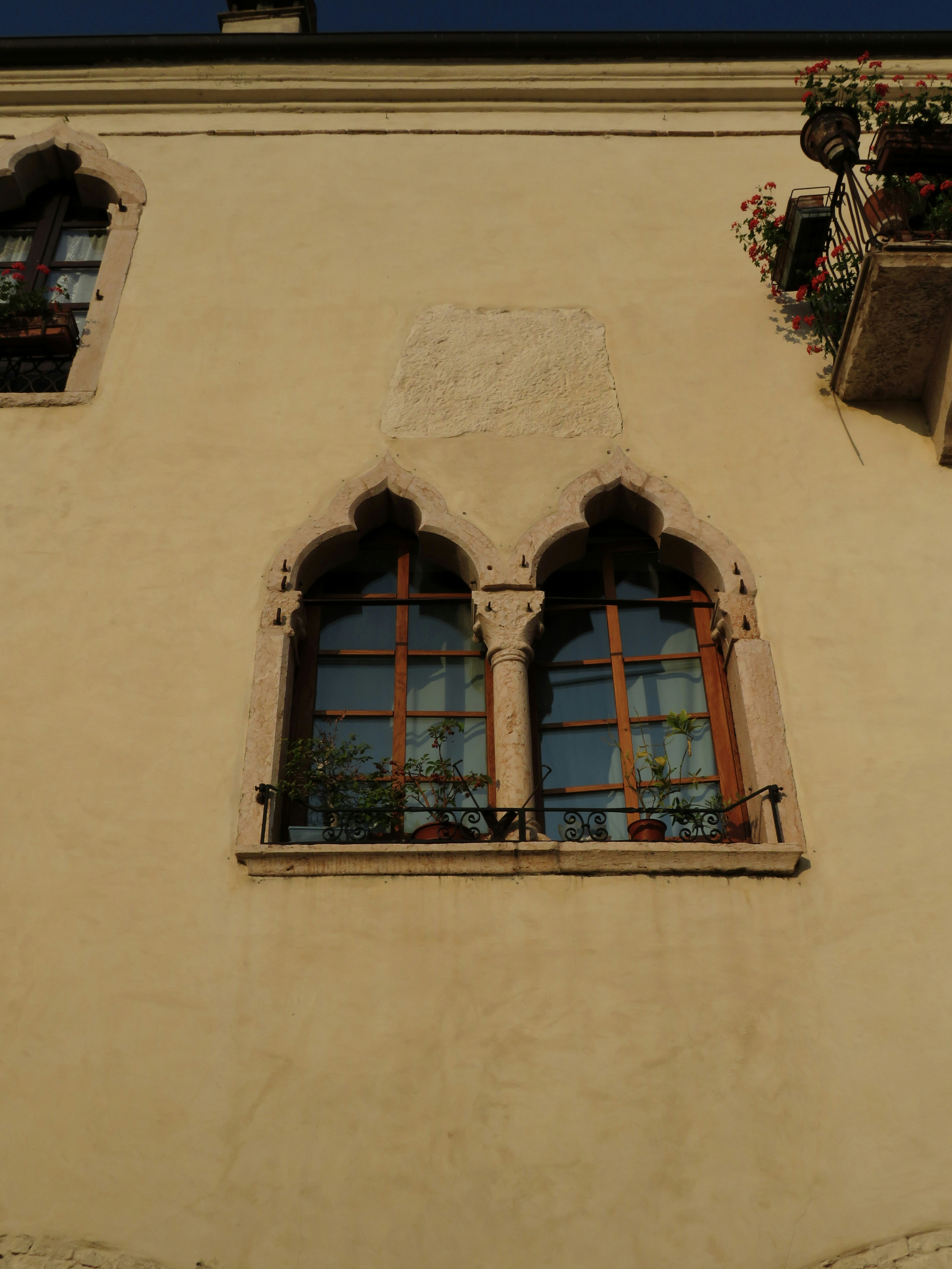 a building with two windows and a clock on the side of it