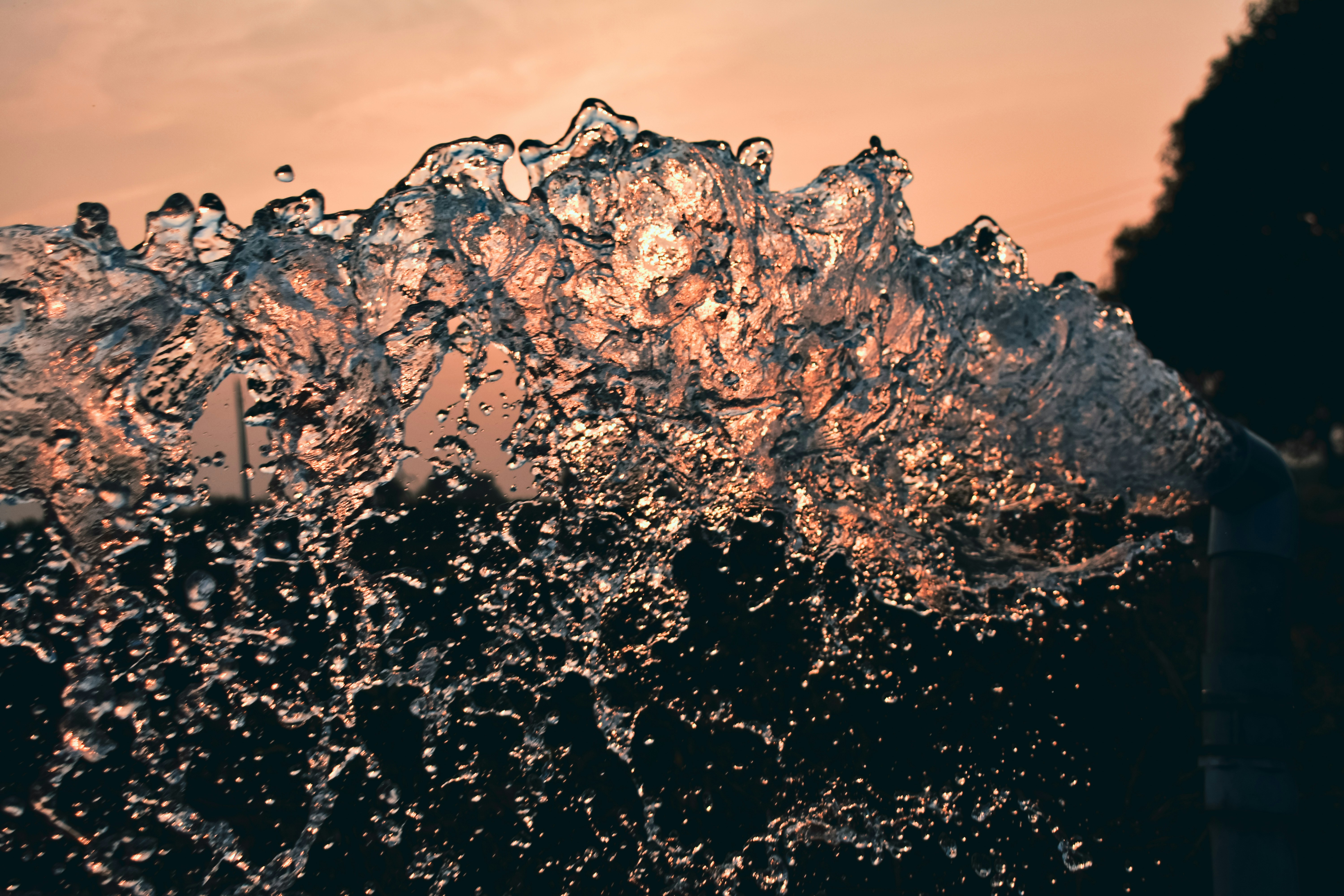a person standing in front of a large wave