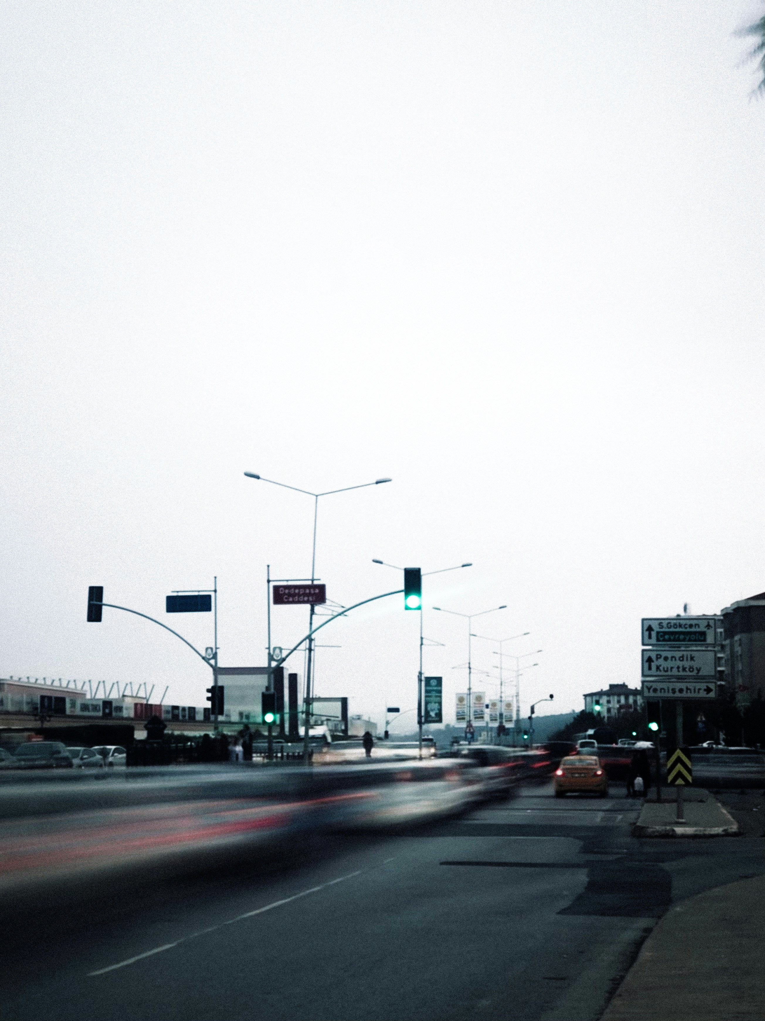 Traffic lights illuminating a busy urban street as cars blur past, showcasing the rhythm of city life.
