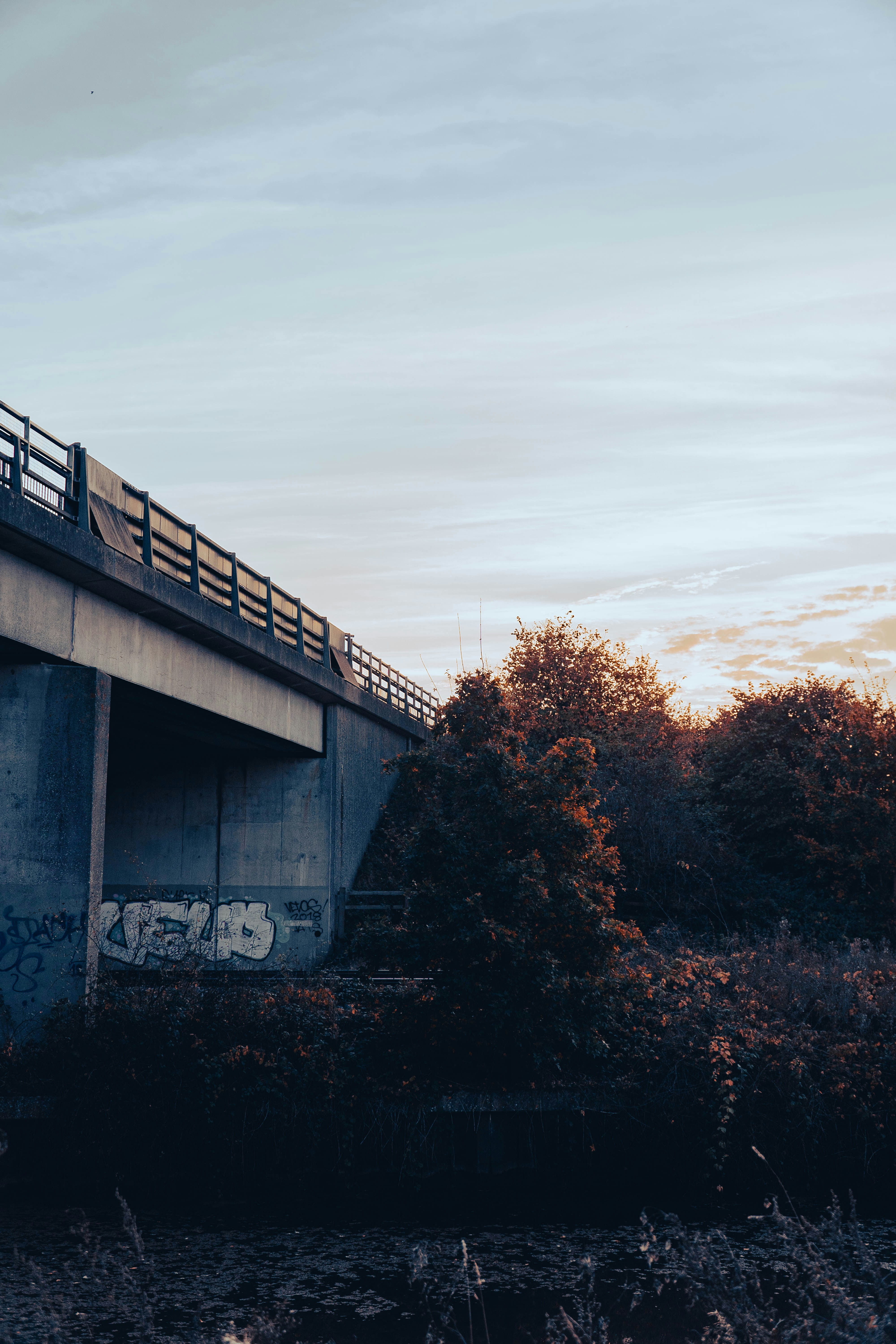 a bridge with graffiti on the side of it