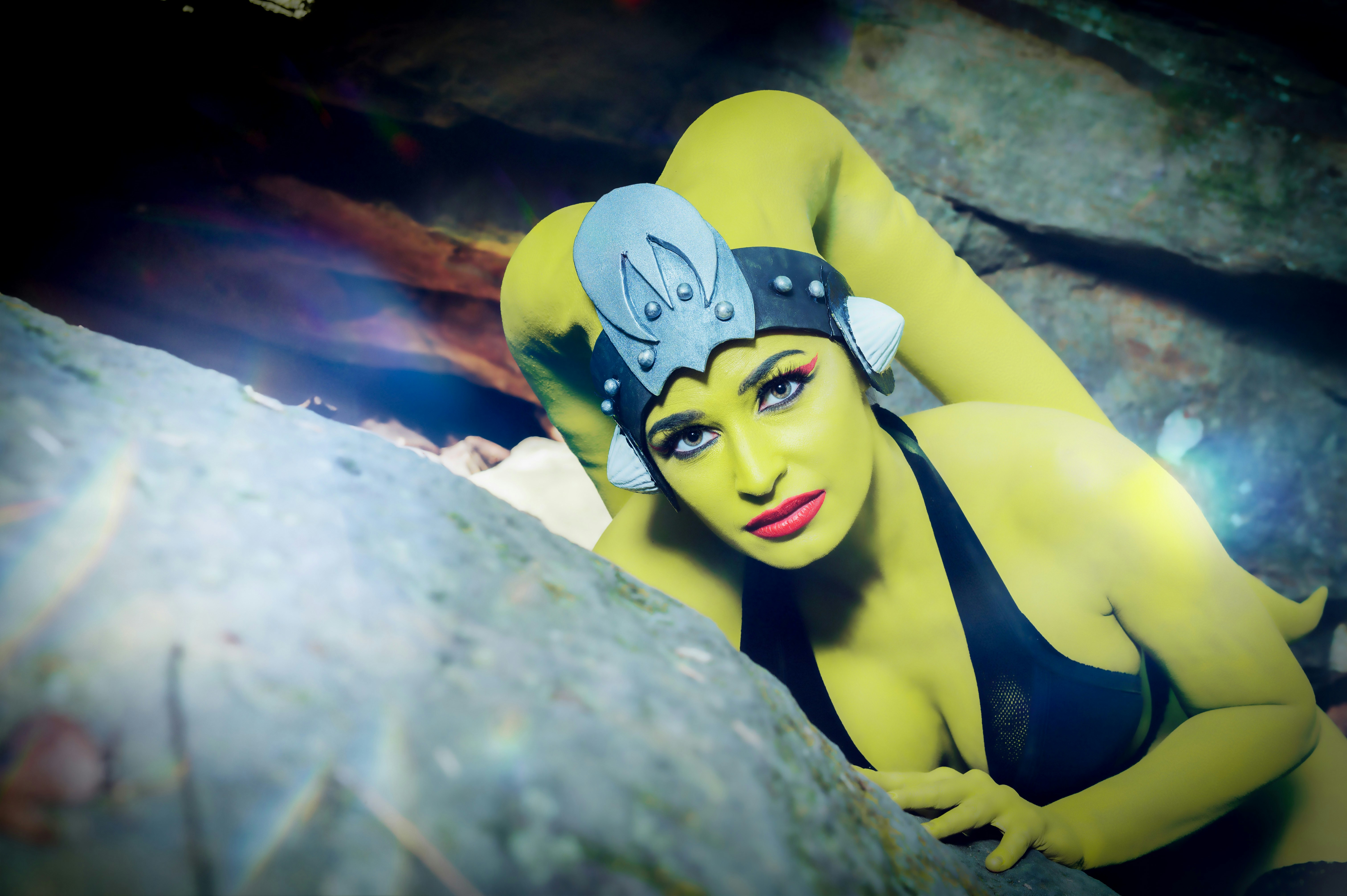 Cavern Siren: Neon Yellow Warrior Amid Blue Grotto