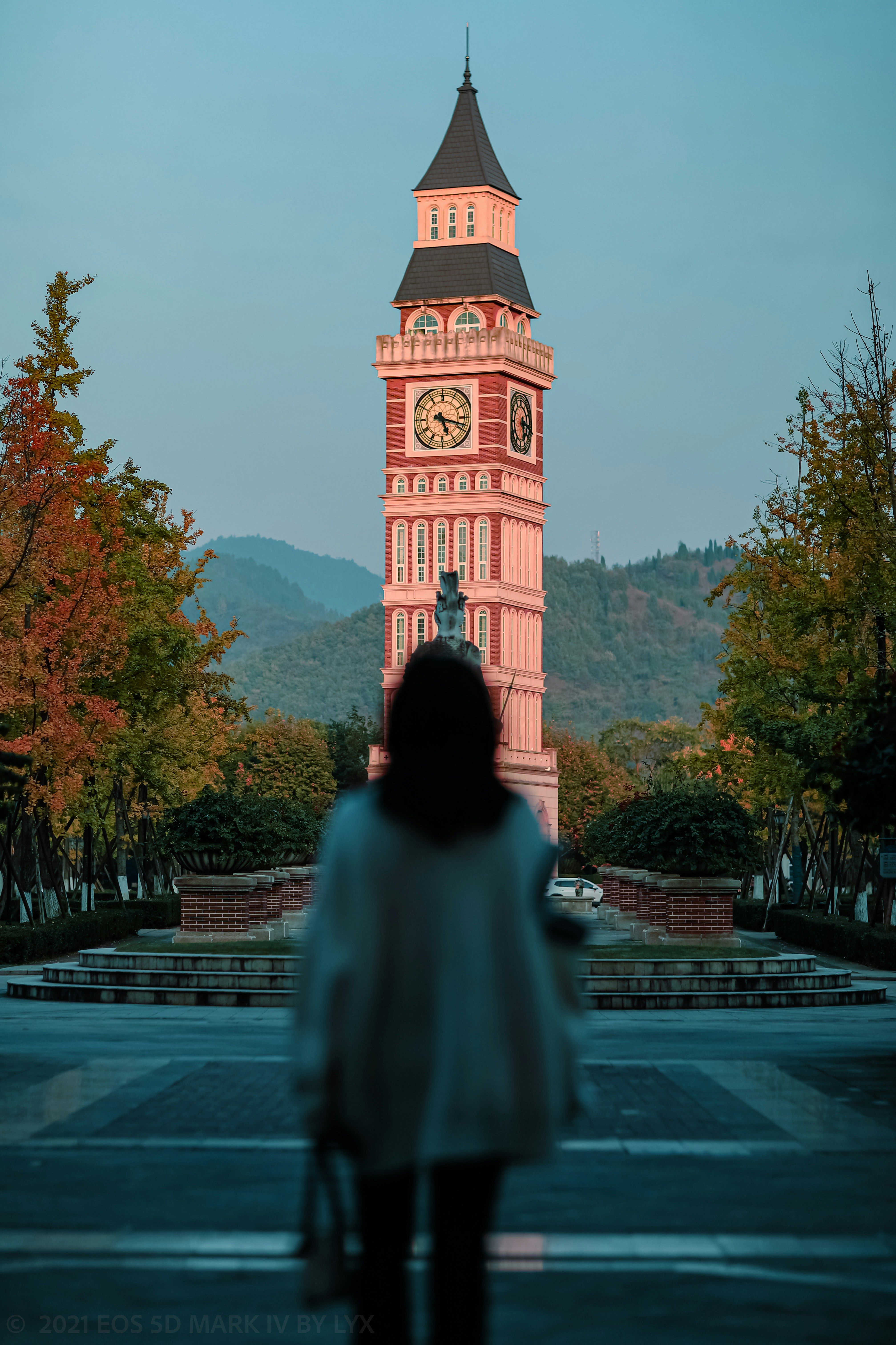 Clocktower Sentinel: A Tourist in the Foreground with Time on Display