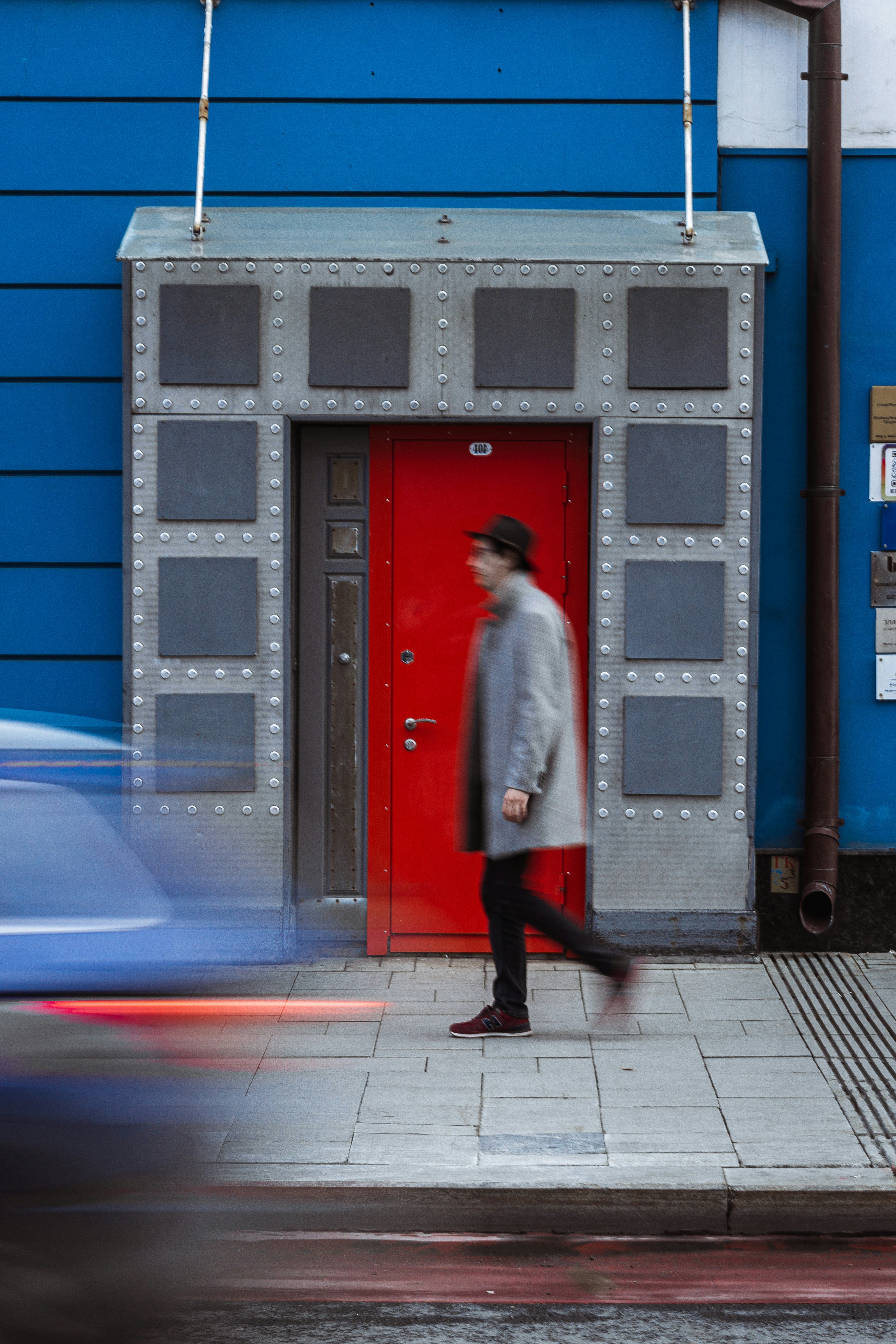 Red Door, Moving Figure: A Moment Along a Neon-Cold Street