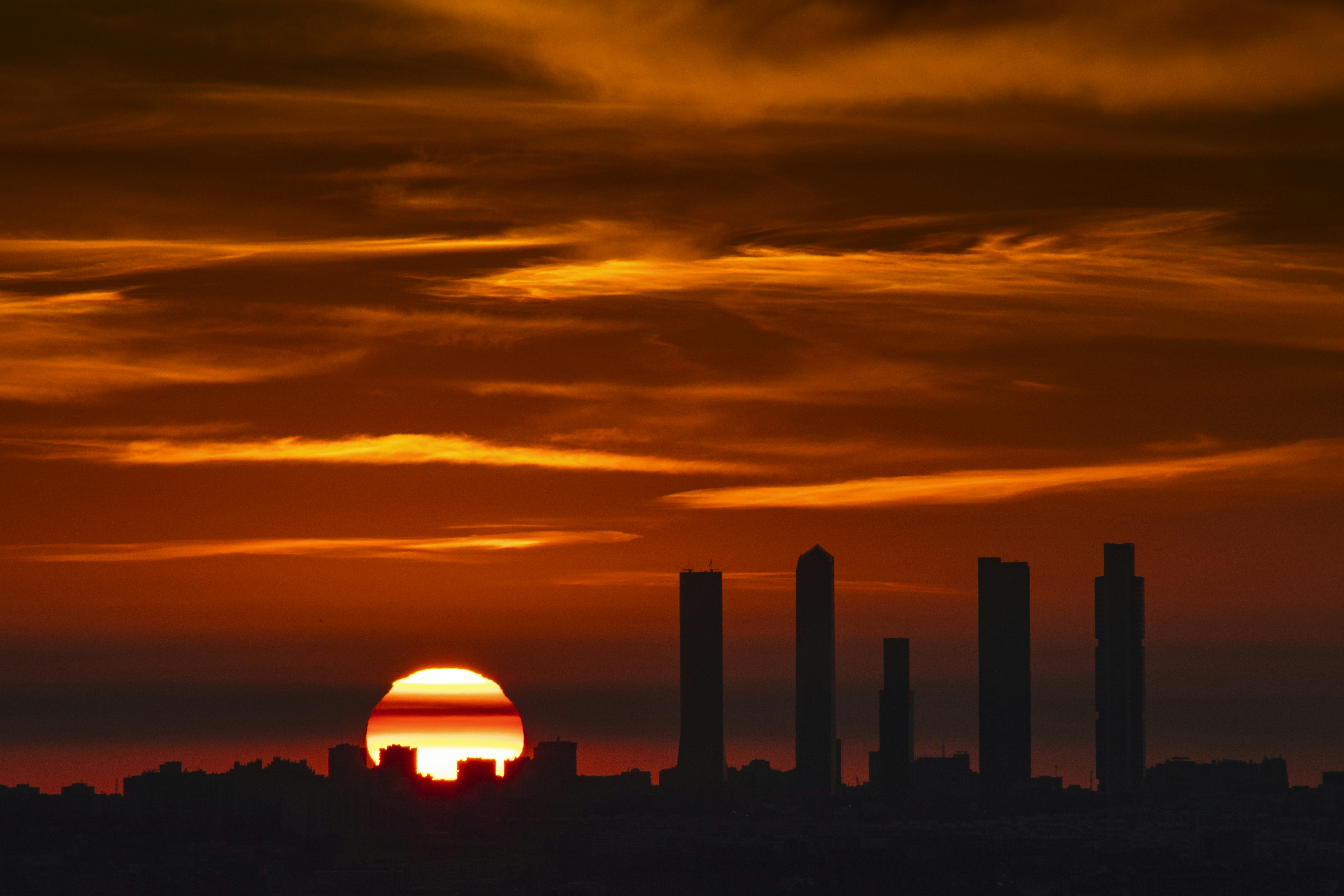 Crimson Dusk Over a Silhouetted Skyline