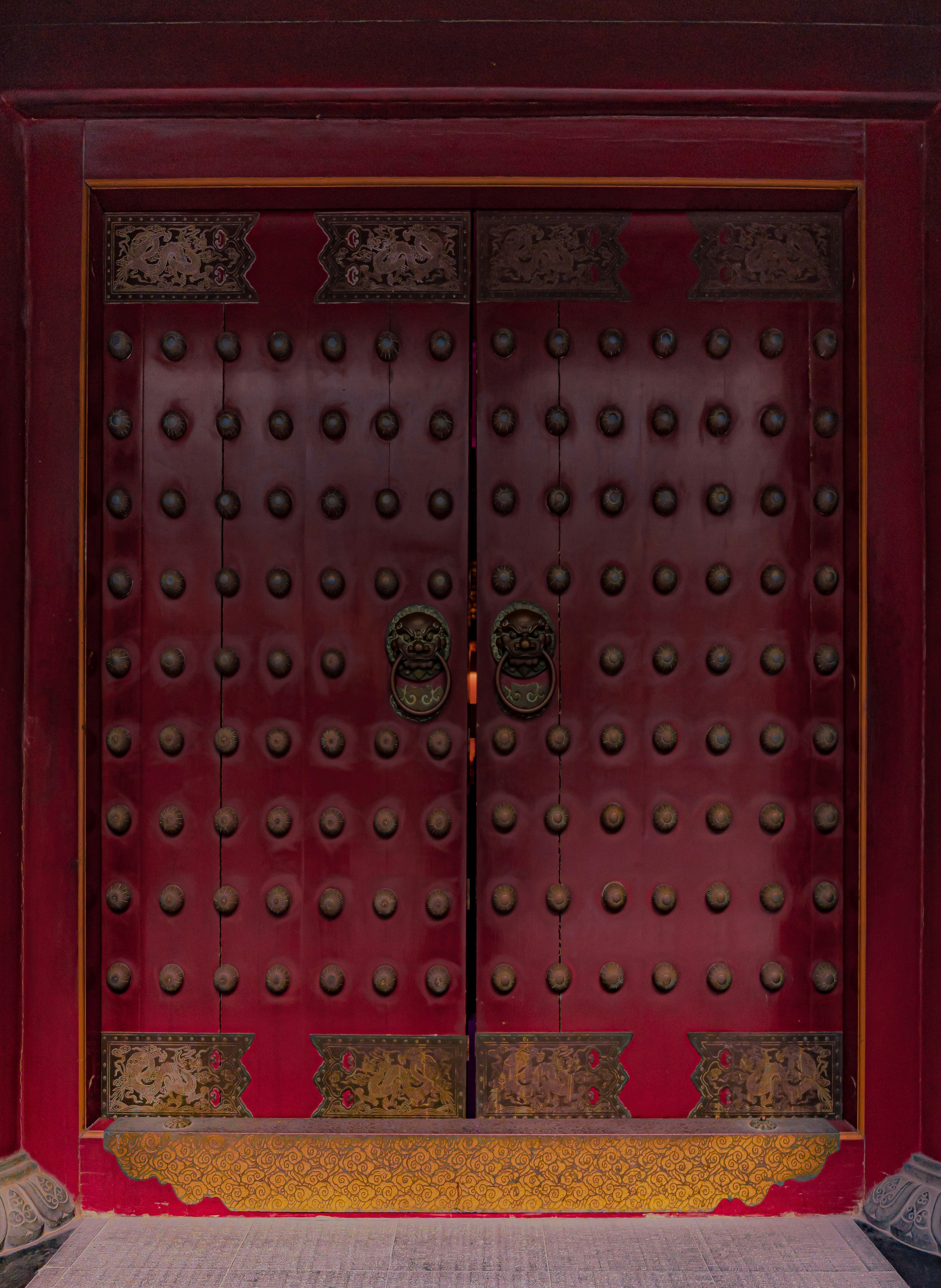 A large red door with metal knobs on it photo – Free Door Image on Unsplash