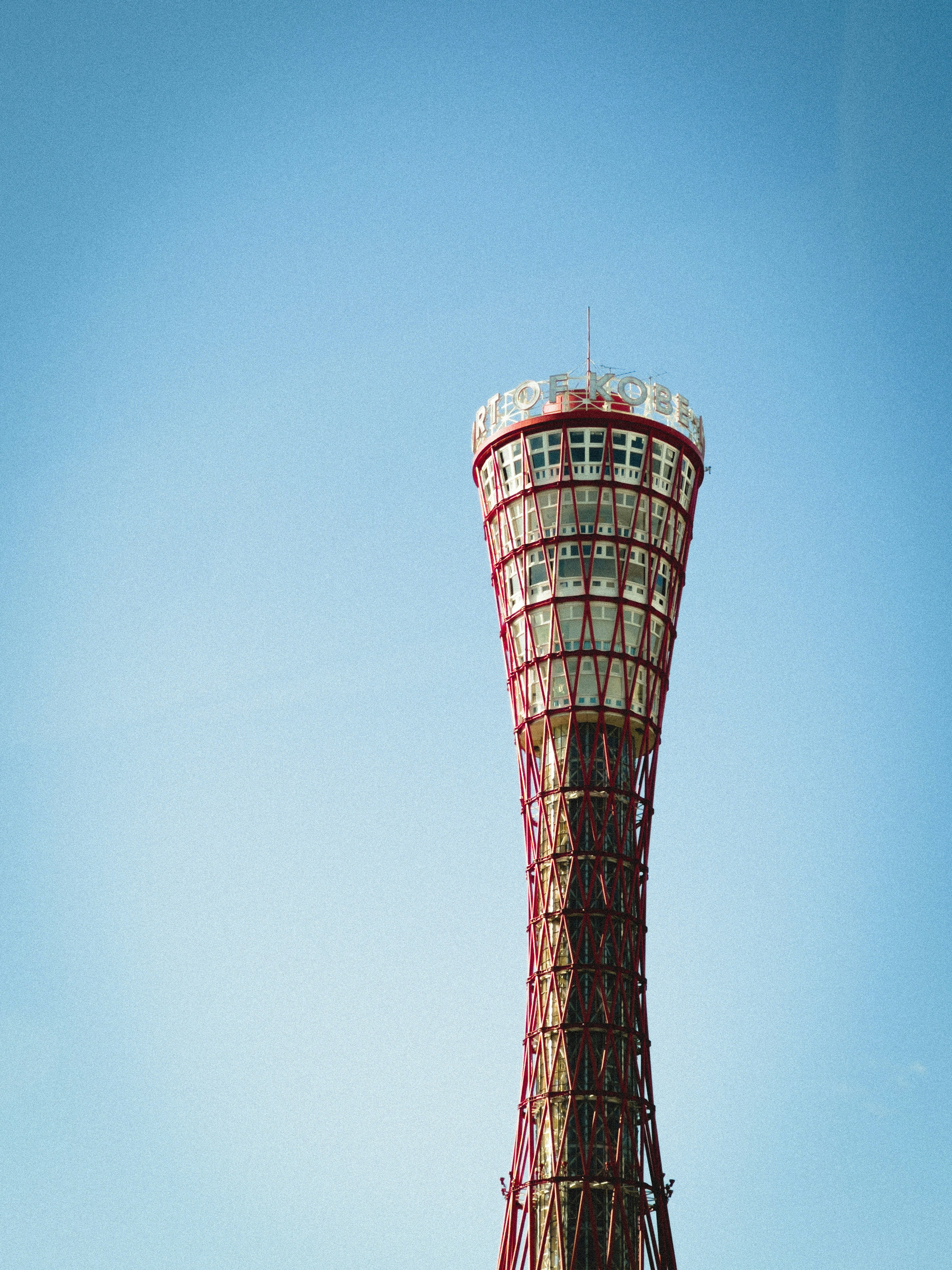 A striking observation tower rises against a clear blue sky, showcasing its unique lattice structure and modern design elements.