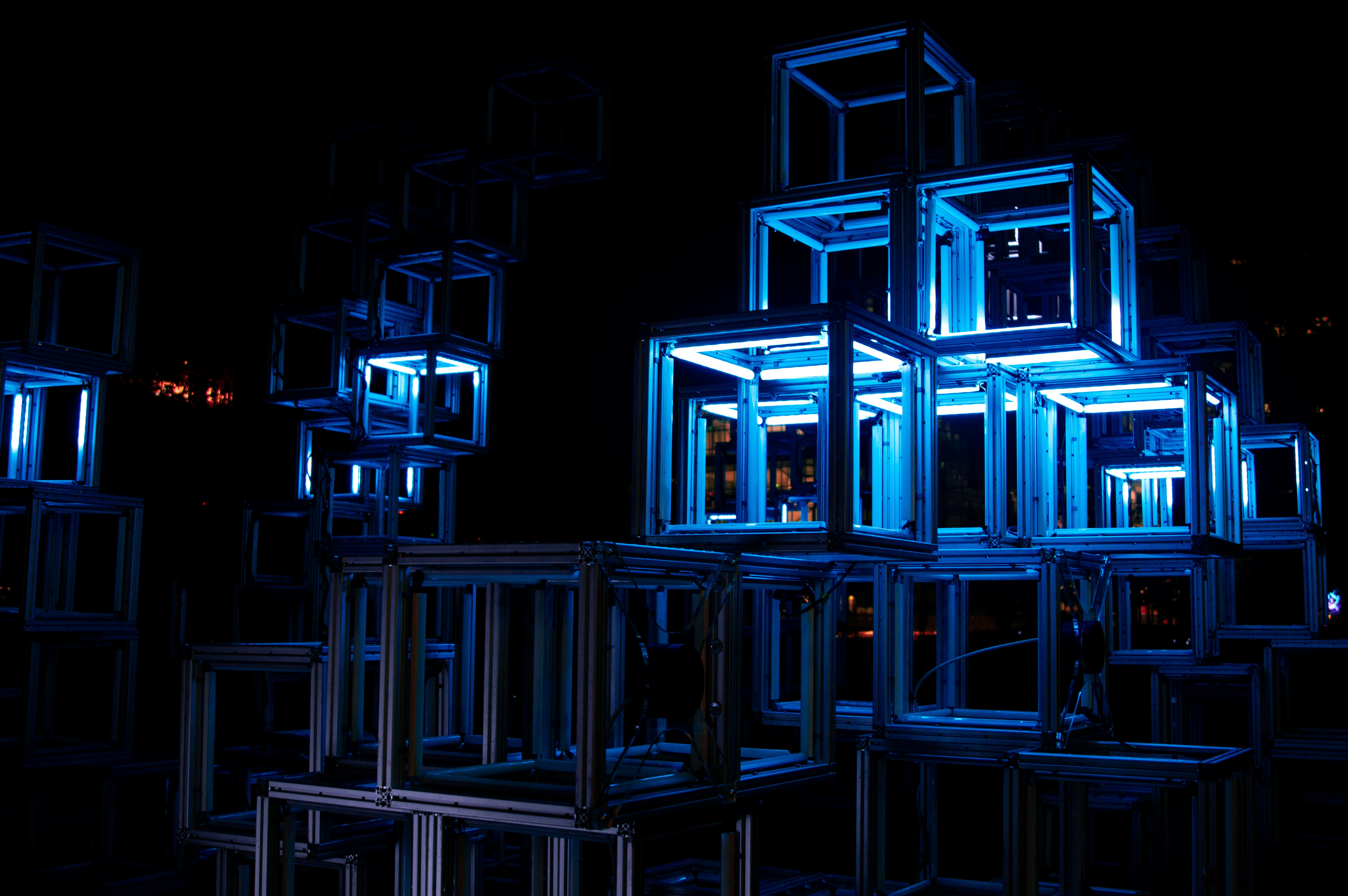Clusters of blue-lit cubes arranged in a complex structure against a dark background.