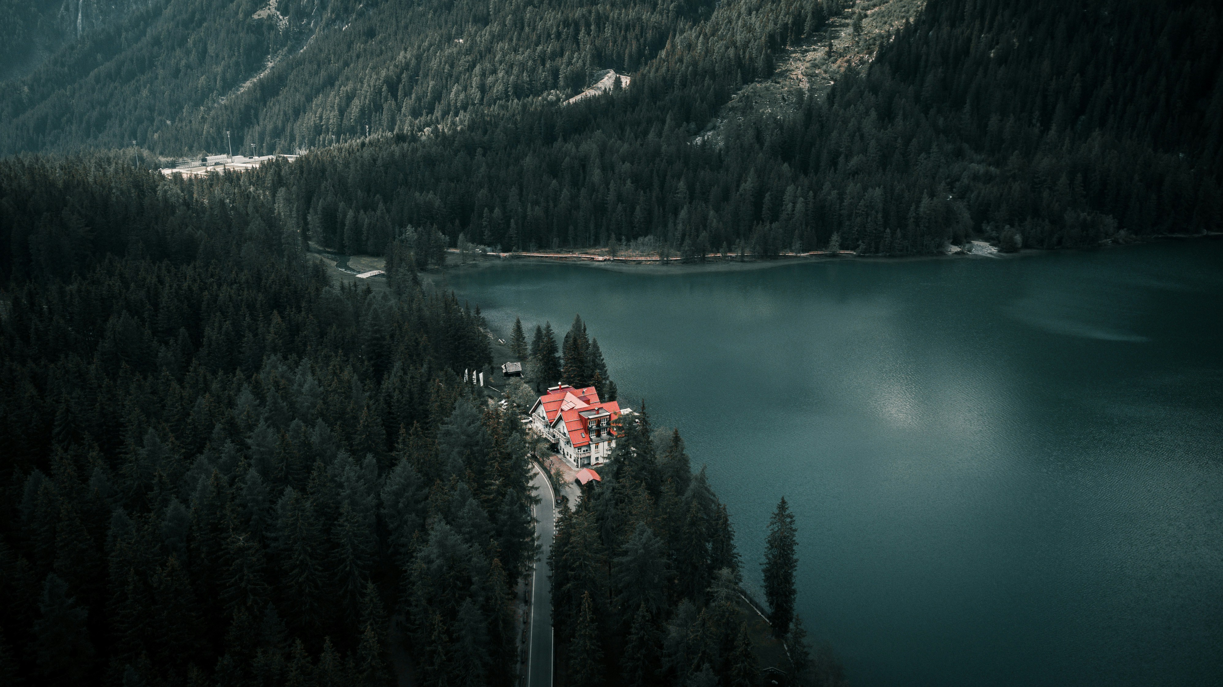 an aerial view of a house in the middle of a forest