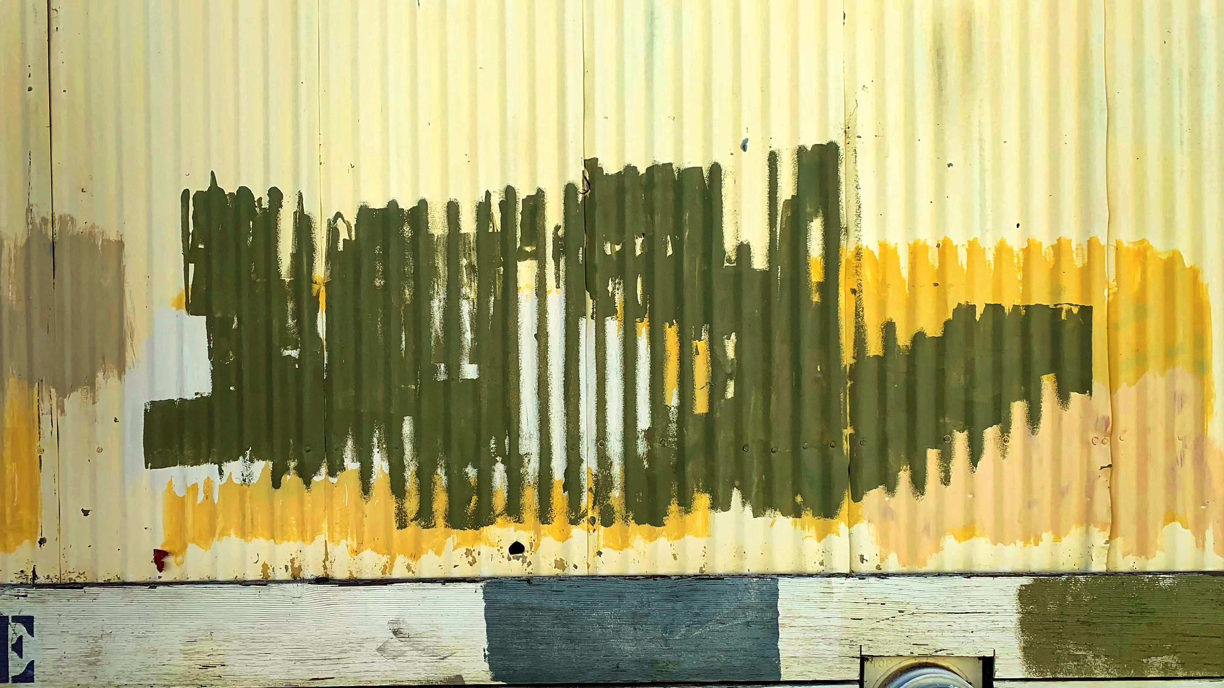 A rusted metal wall with yellow and green paint photo – Free Background ...
