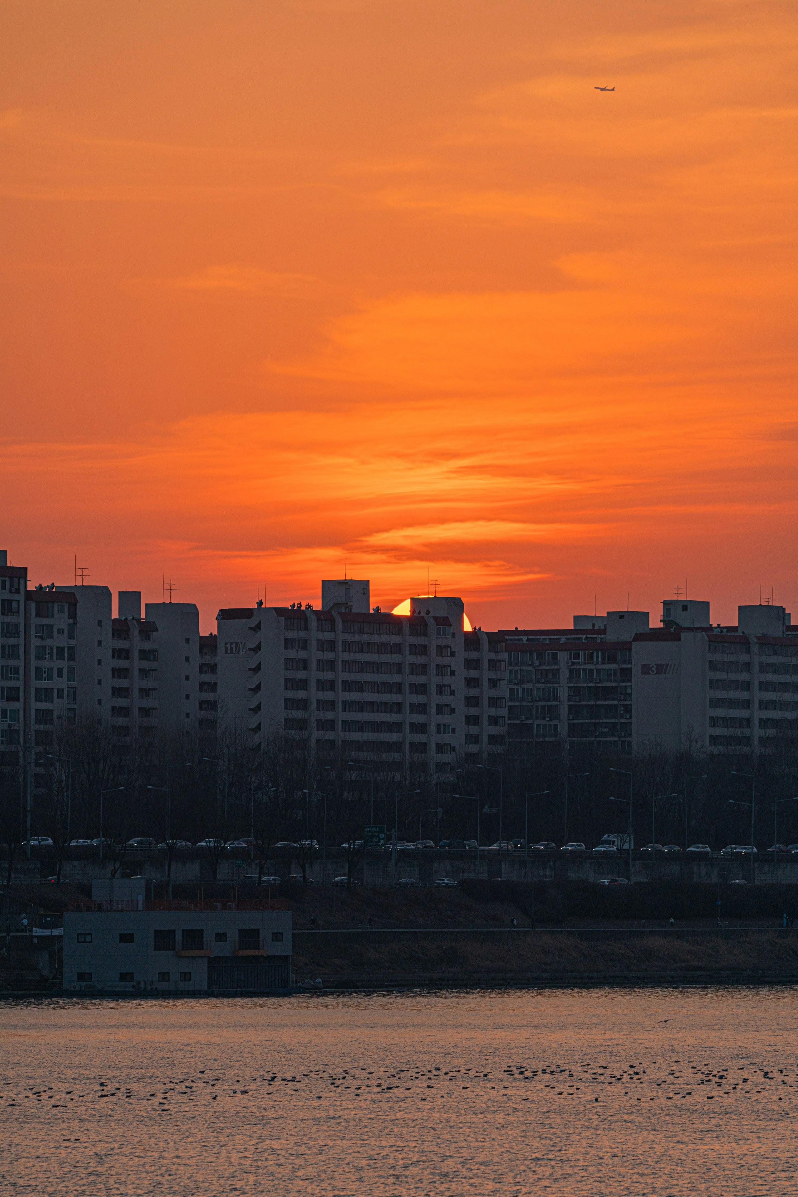 the sun is setting over a large city