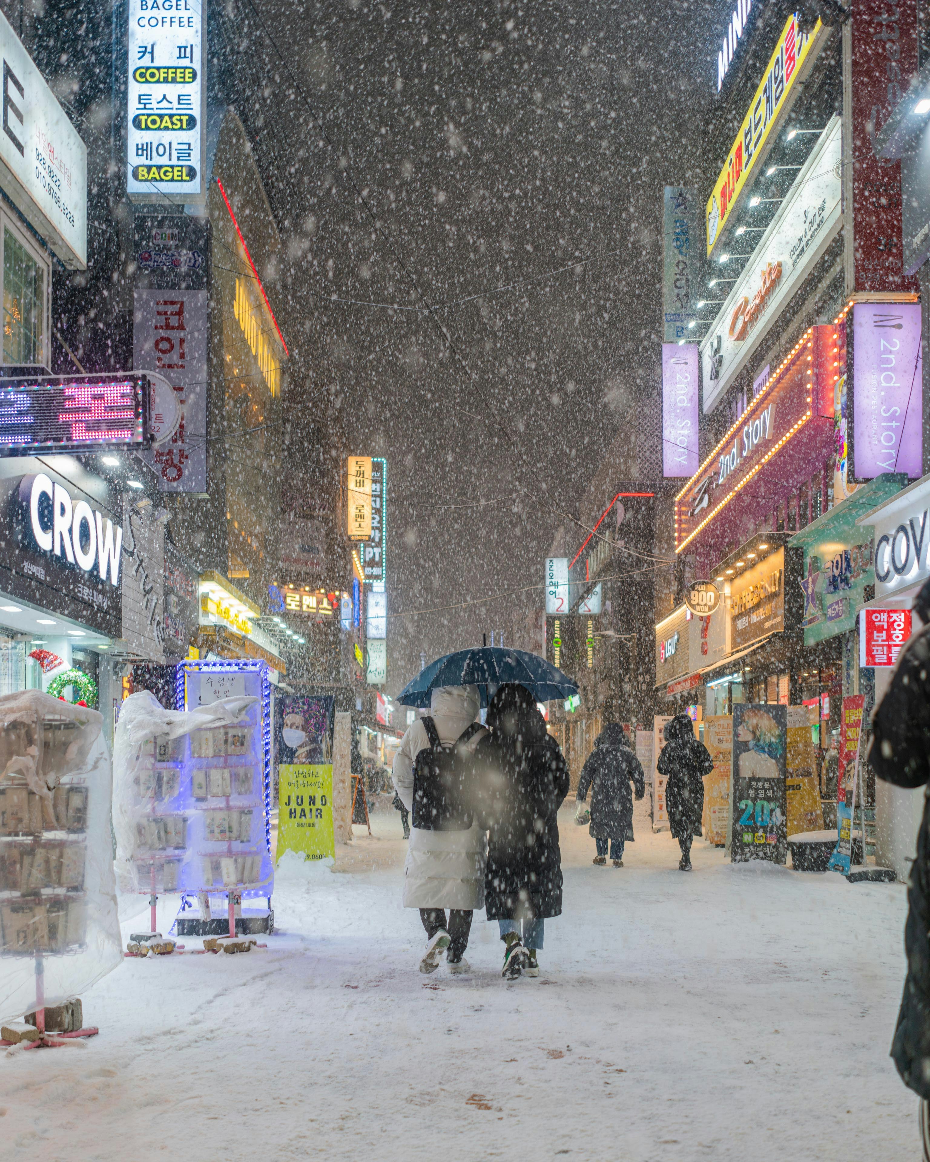 Snowy Neon Street: Lovers under an Umbrella in a City of Light