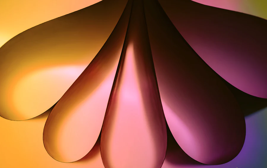 Layered abstract petal-like forms in orange, pink, and purple gradients with glossy shadows. A soft glowing center draws the eye upward through the composition.