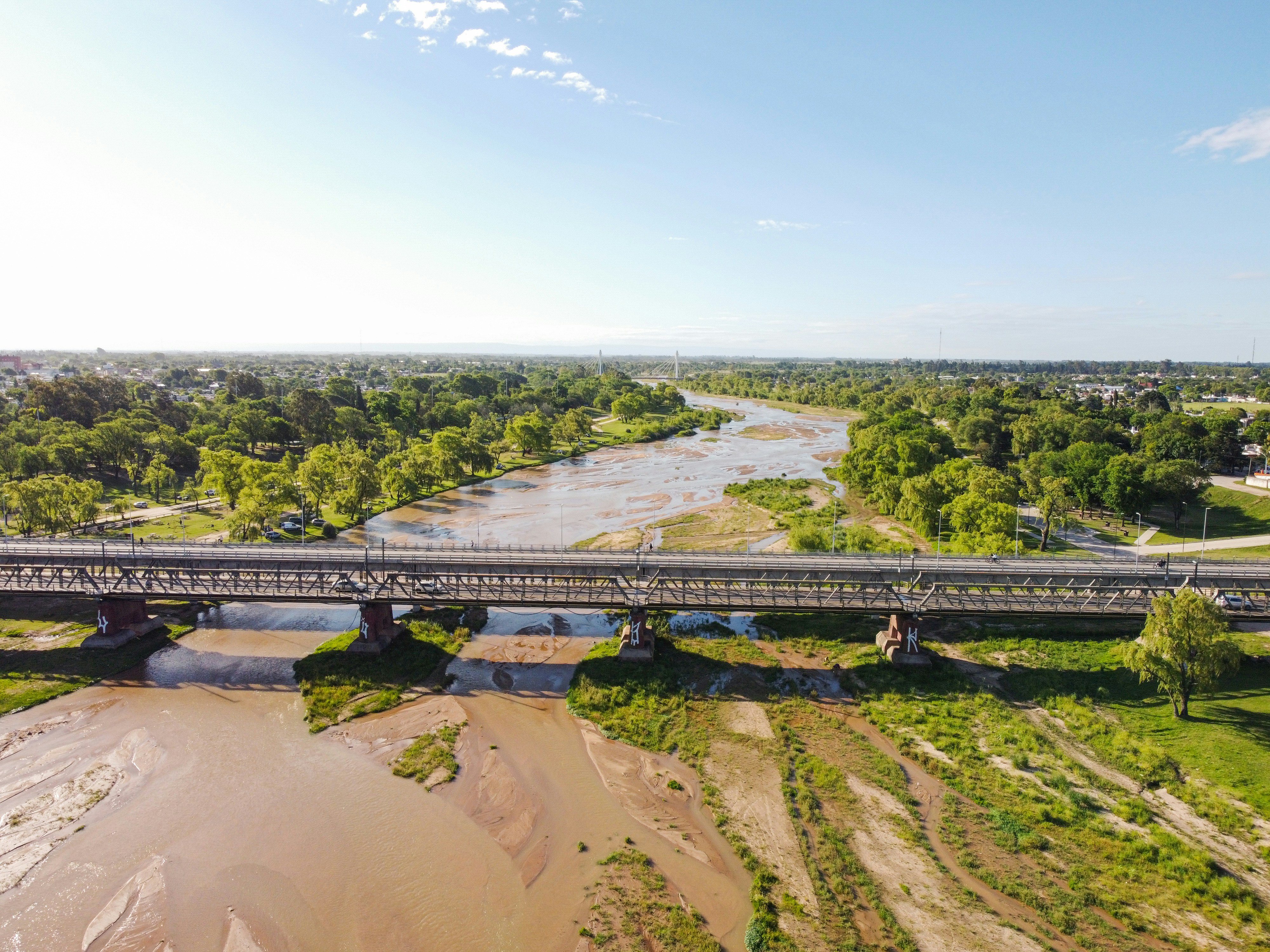 Steel Ribbon Over a Quiet River: An Aerial Study of Light and Landscape