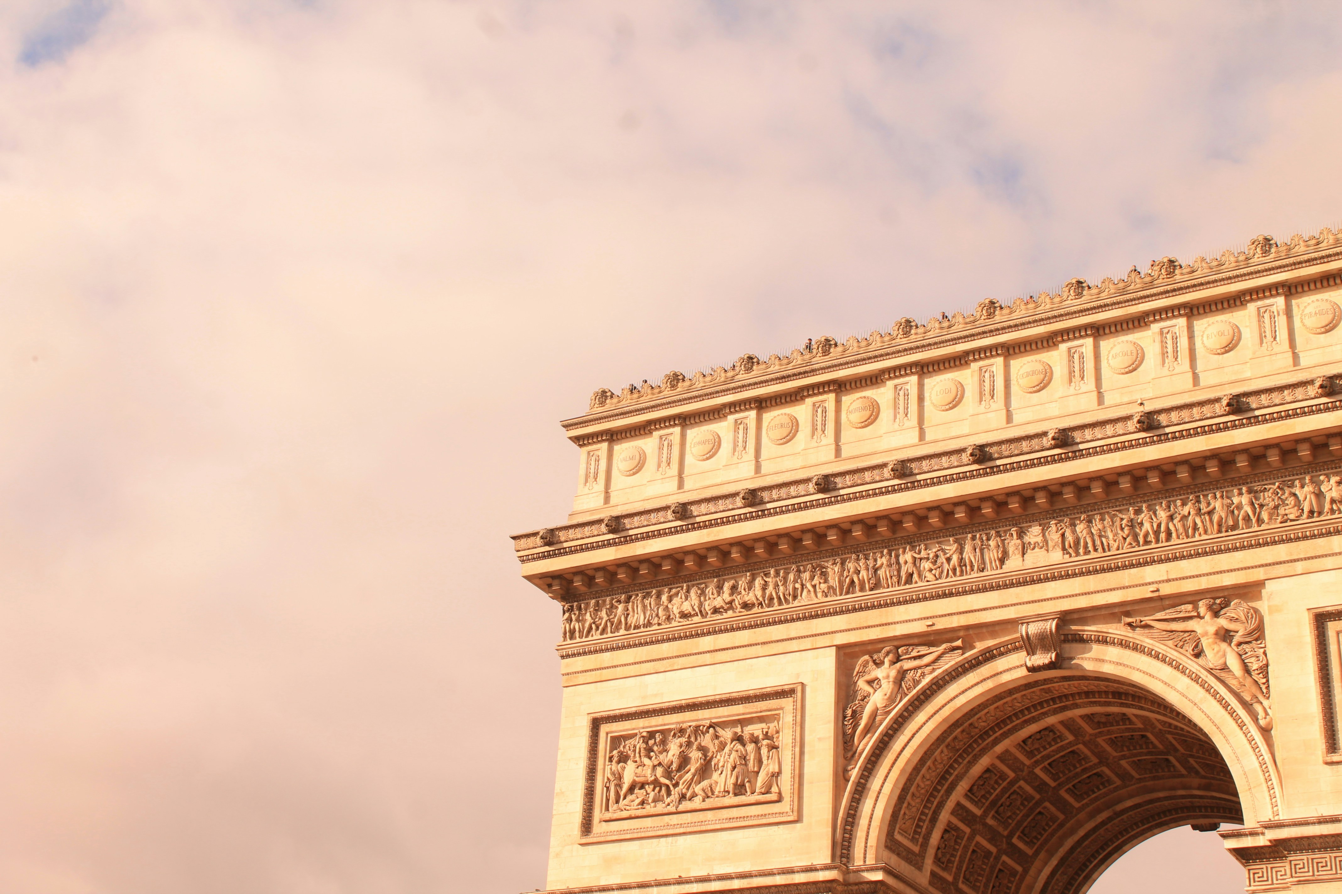 Warm Marble Arc: Sunlit Frieze of a Paris Monument