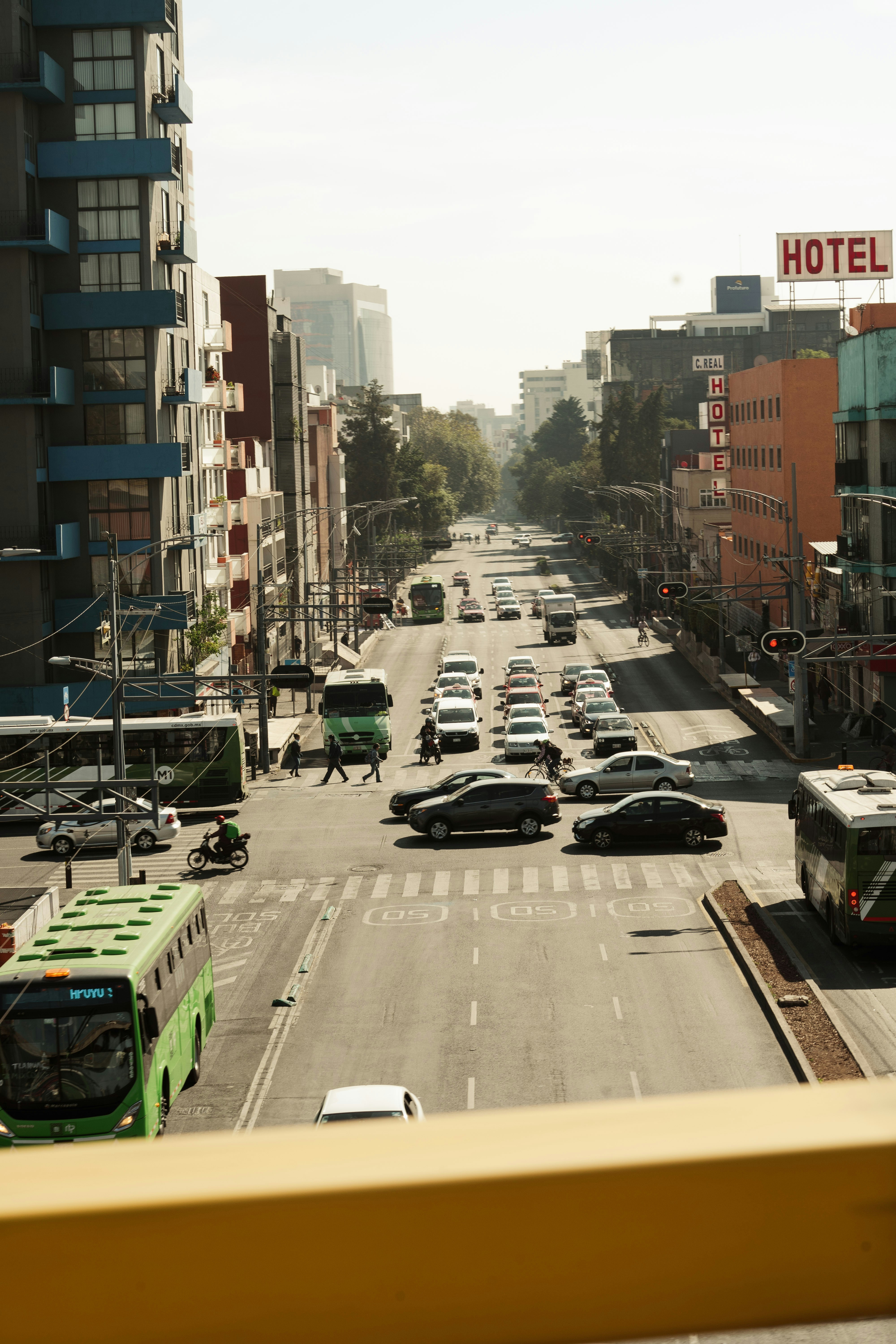 A city street with cars and buses on it photo – Free Mexico Image on ...