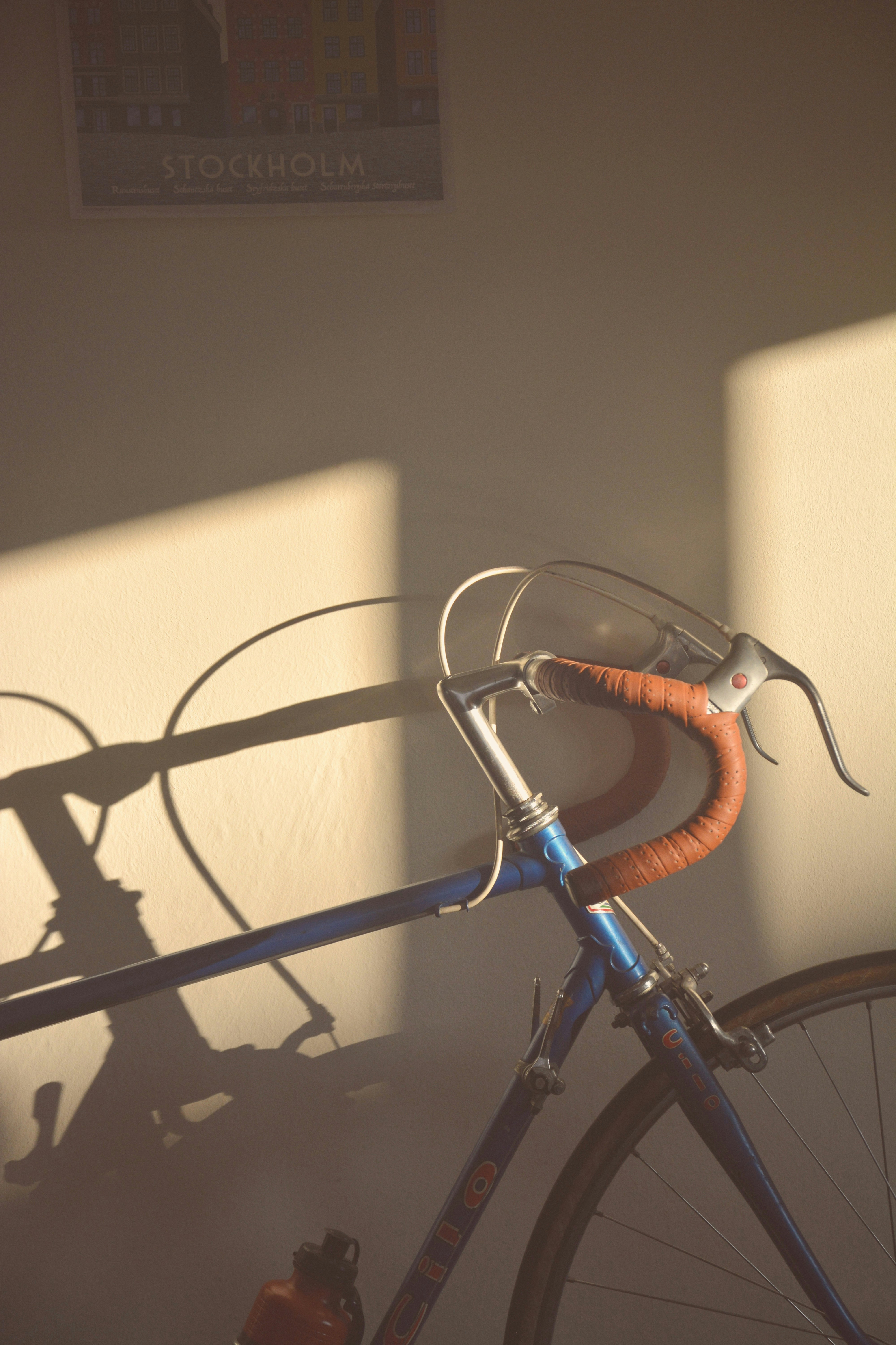 Golden Hour on Two Wheels: A Vintage Blue Bicycle in Shadowed Light