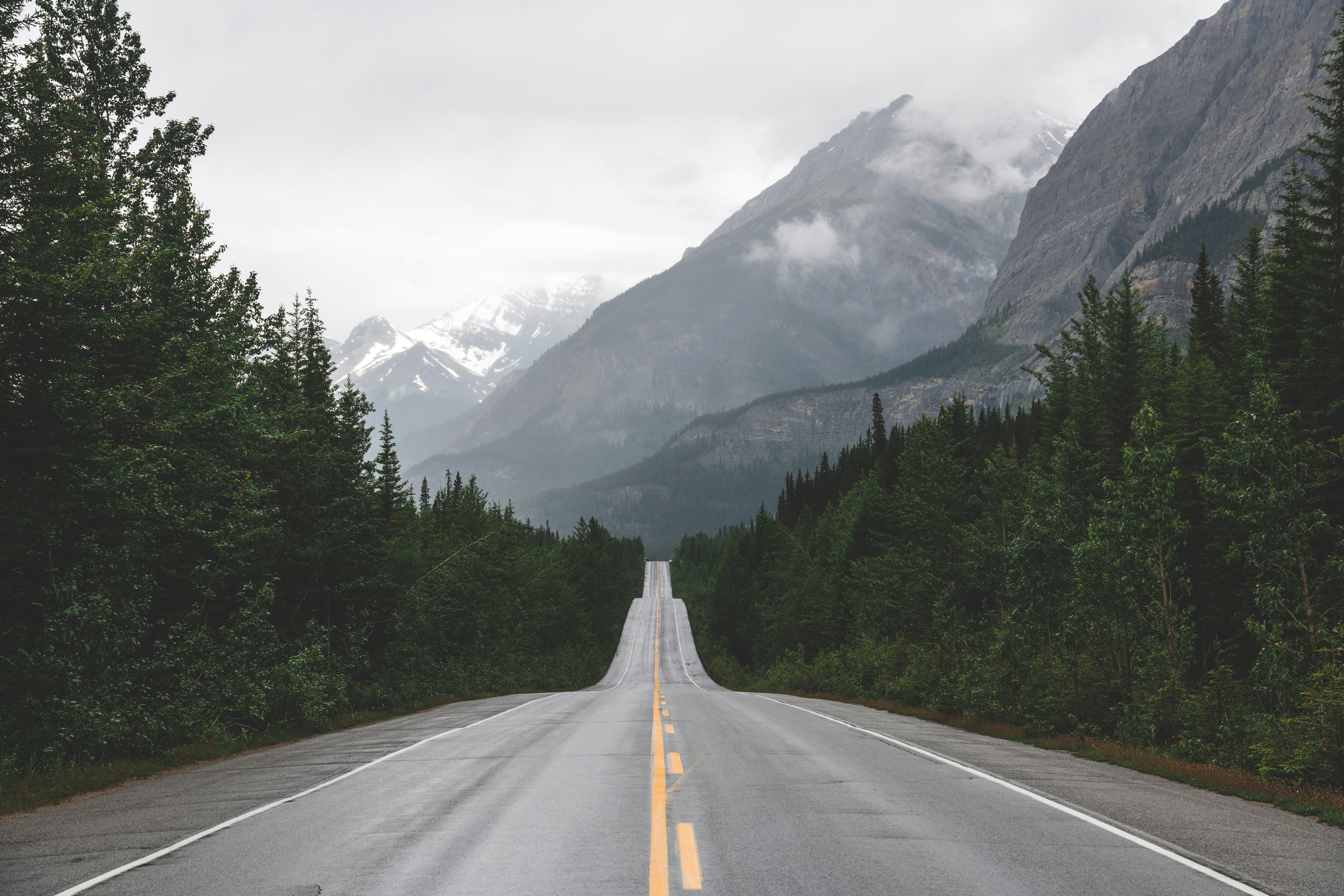 A long road with a mountain in the background photo – Free Wallpapers ...