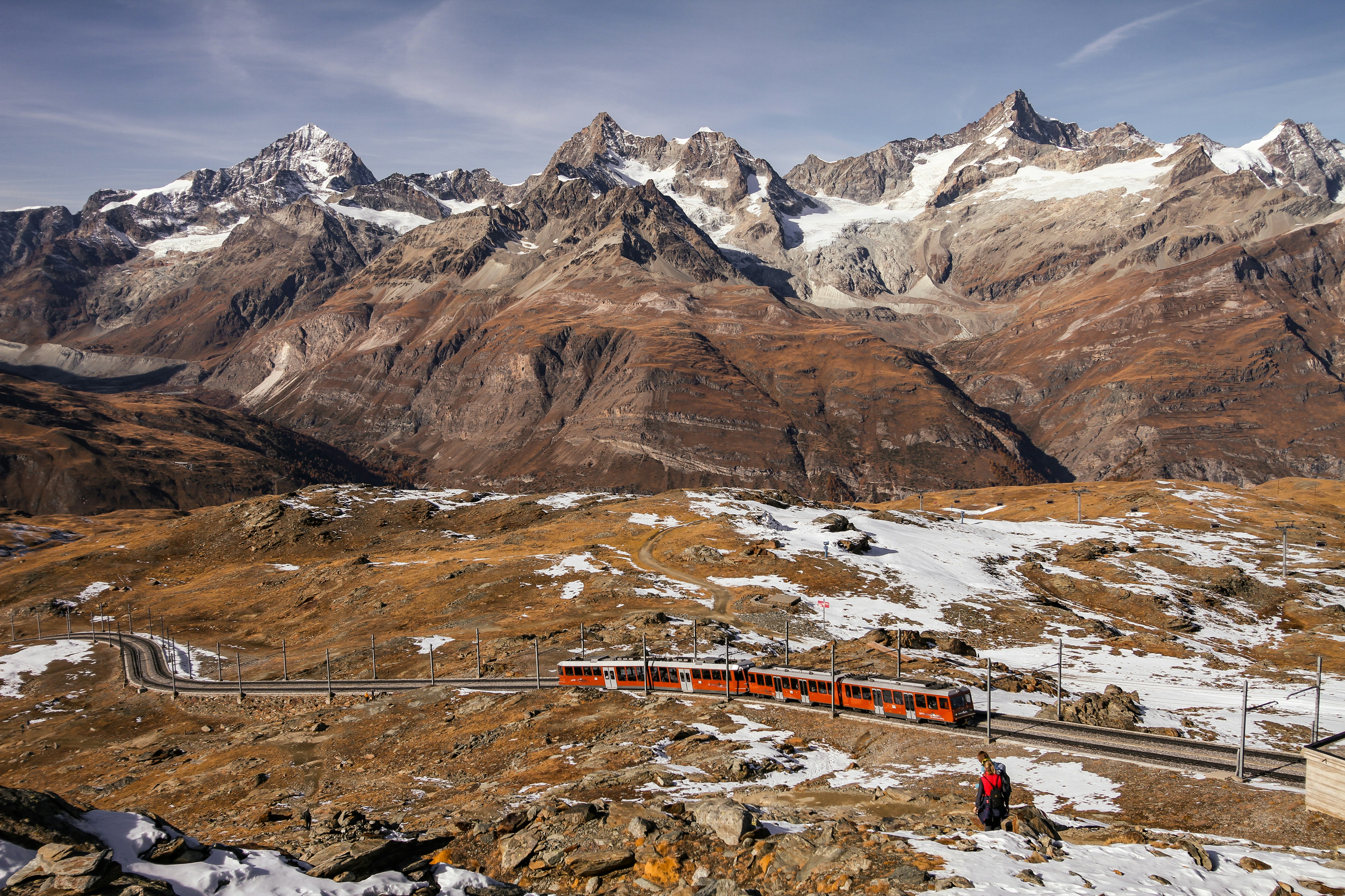 a train traveling through a snow covered mountain range