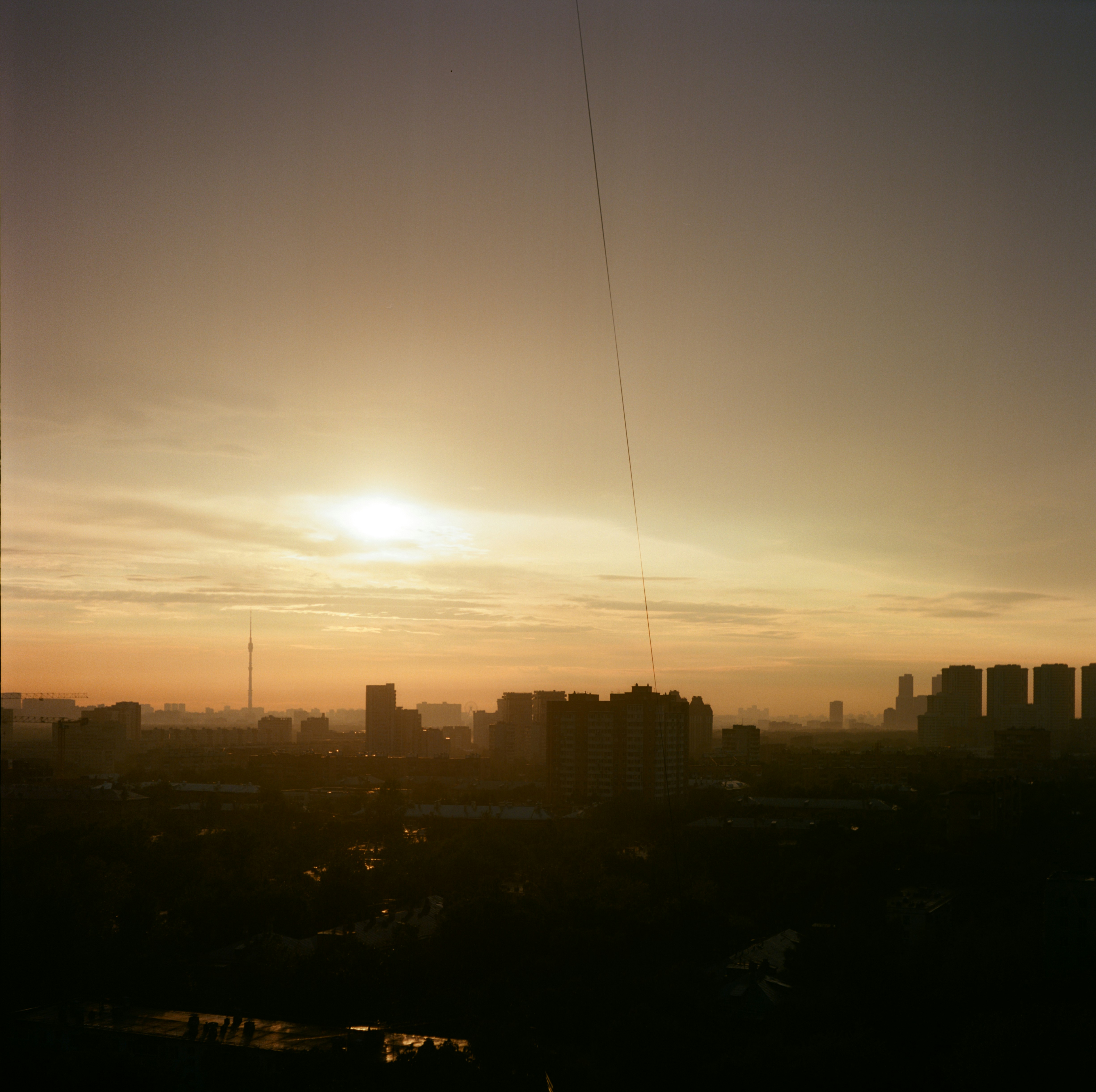 The sun is setting over a city with tall buildings photo – Free Dusk ...