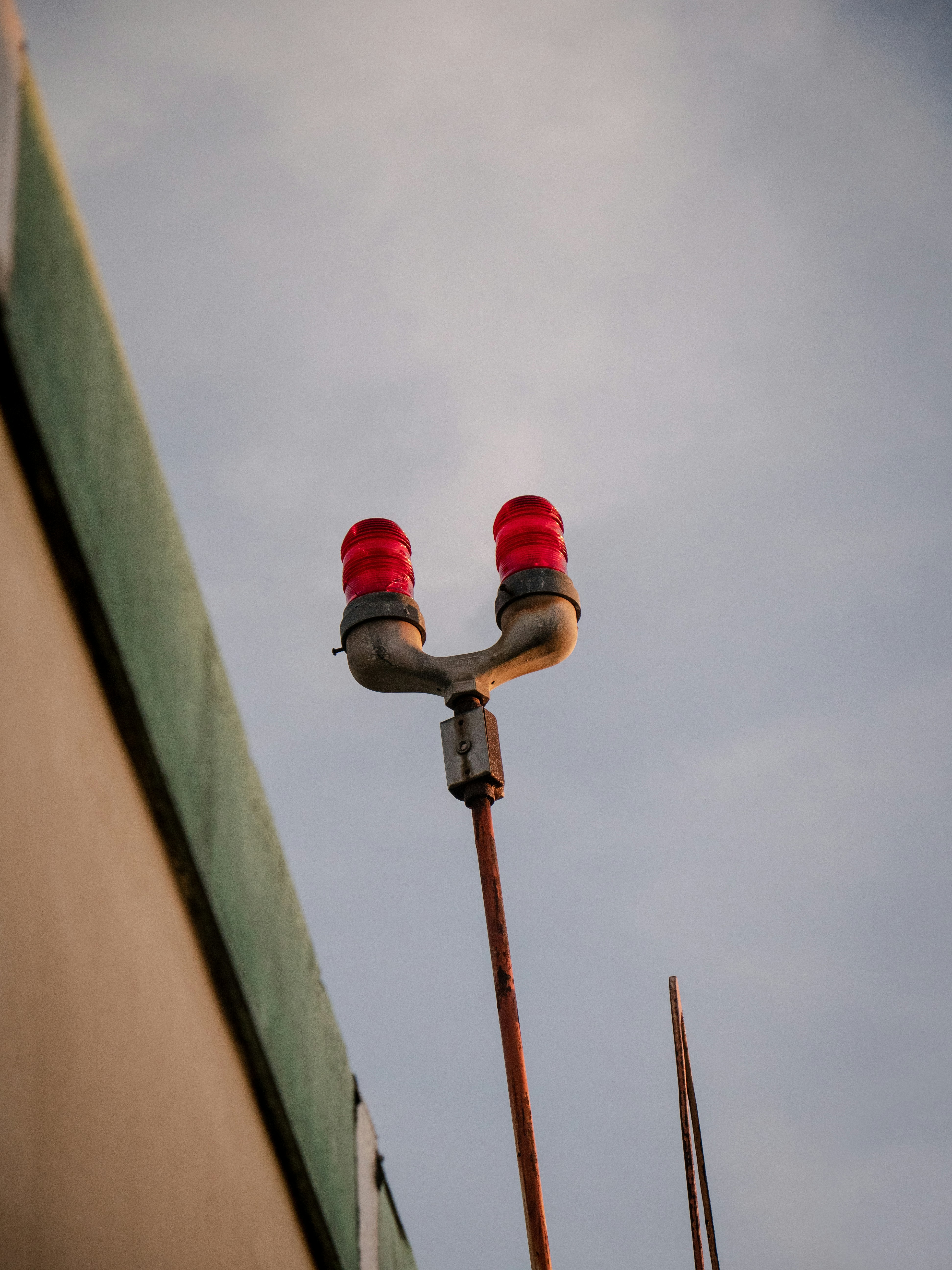 a red traffic light sitting on the side of a building