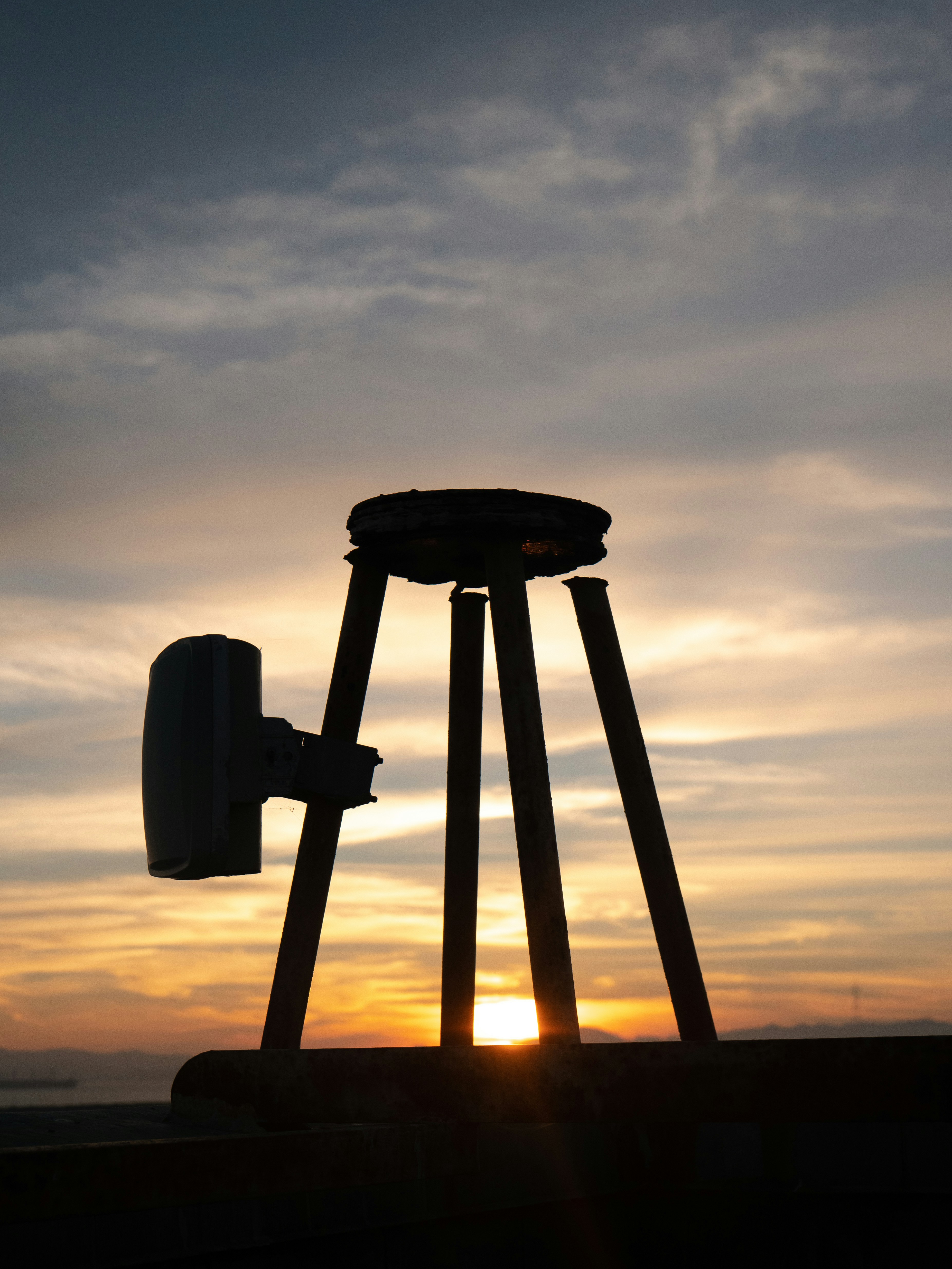 Silhouette of a Tripod at Sunset, Framing a Quiet Horizon