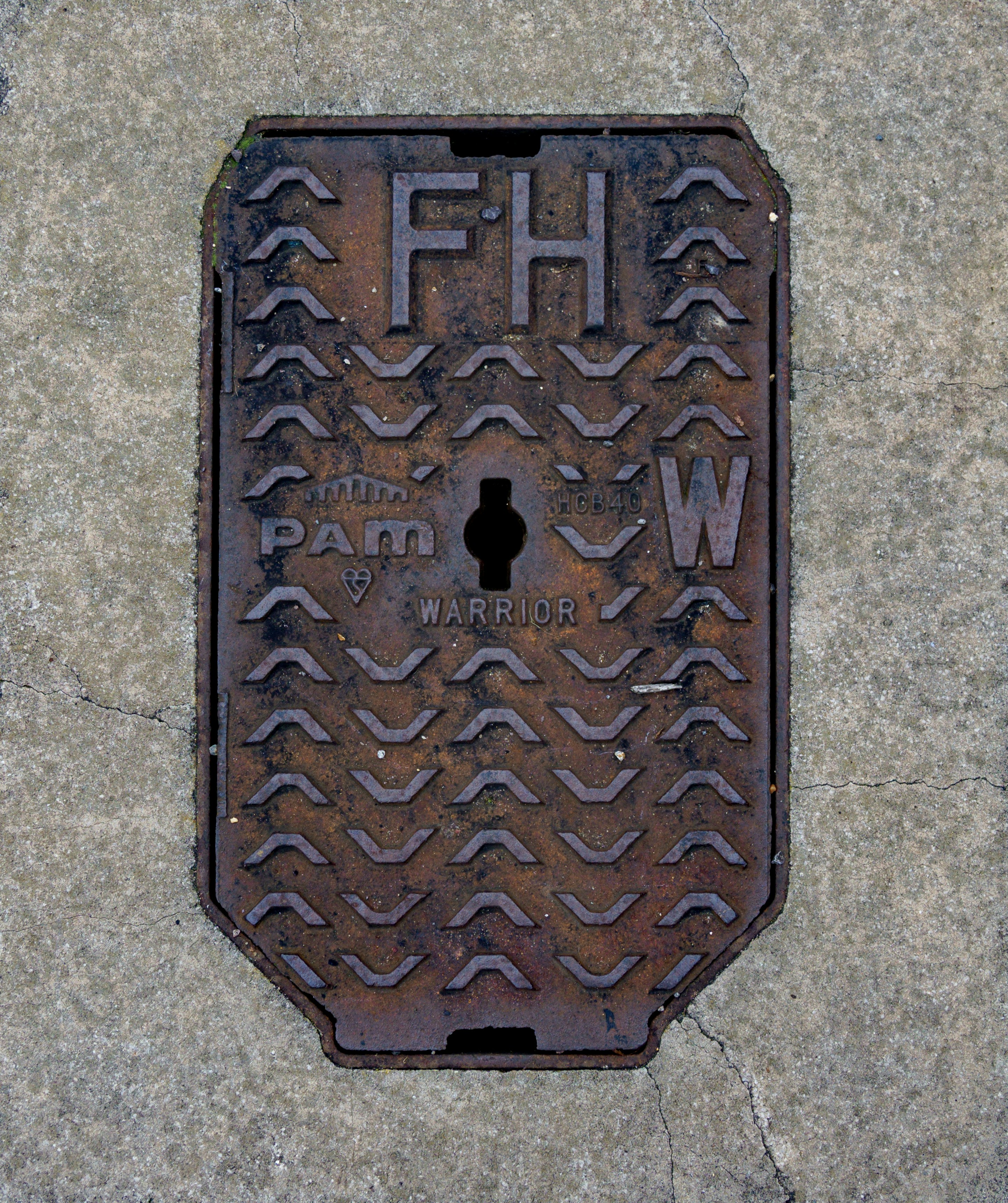 A manhole cover on the ground with a lock on it photo – Free Grey Image ...