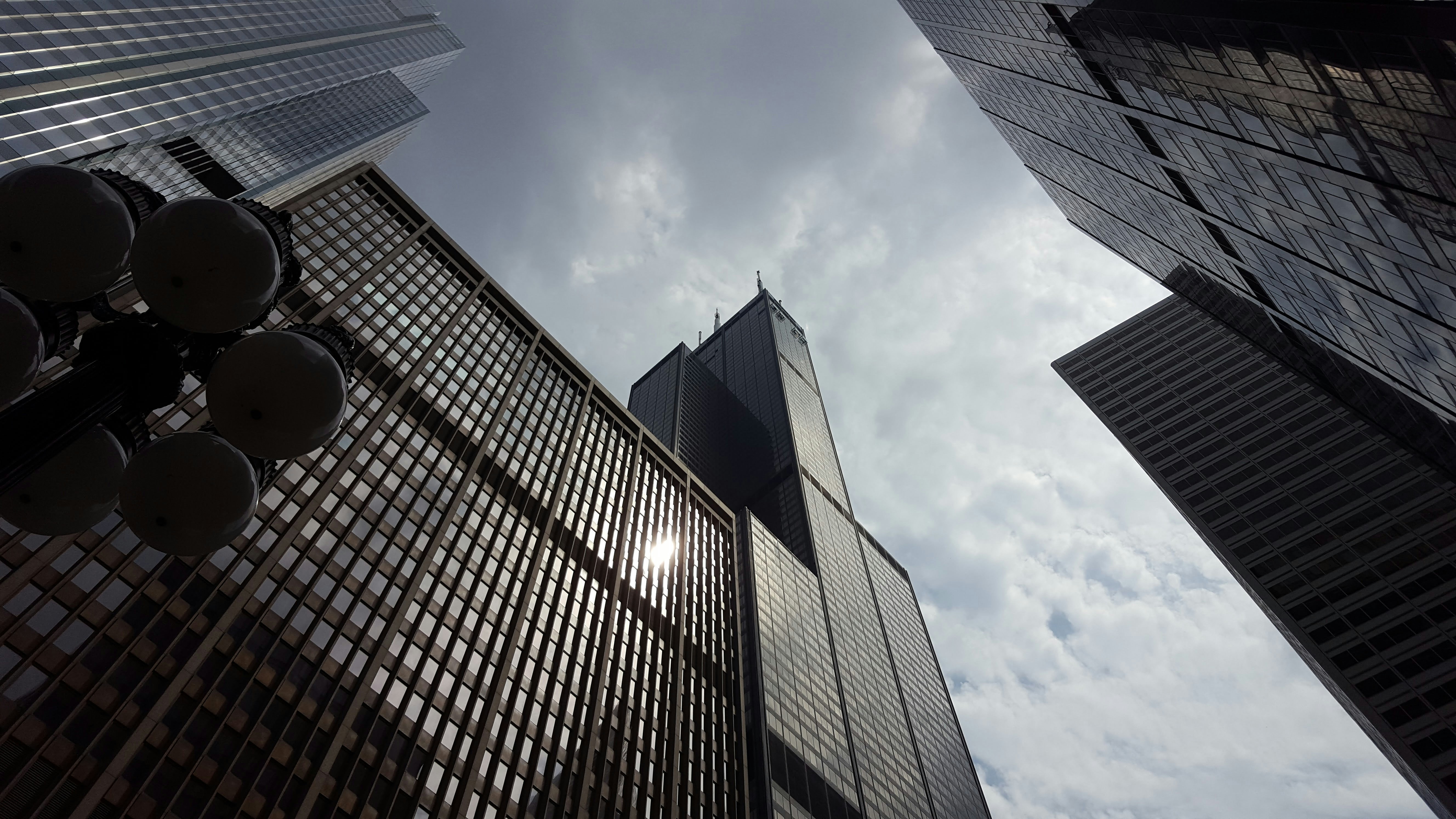 Looking up at tall buildings in a city photo – Free High rise Image on ...