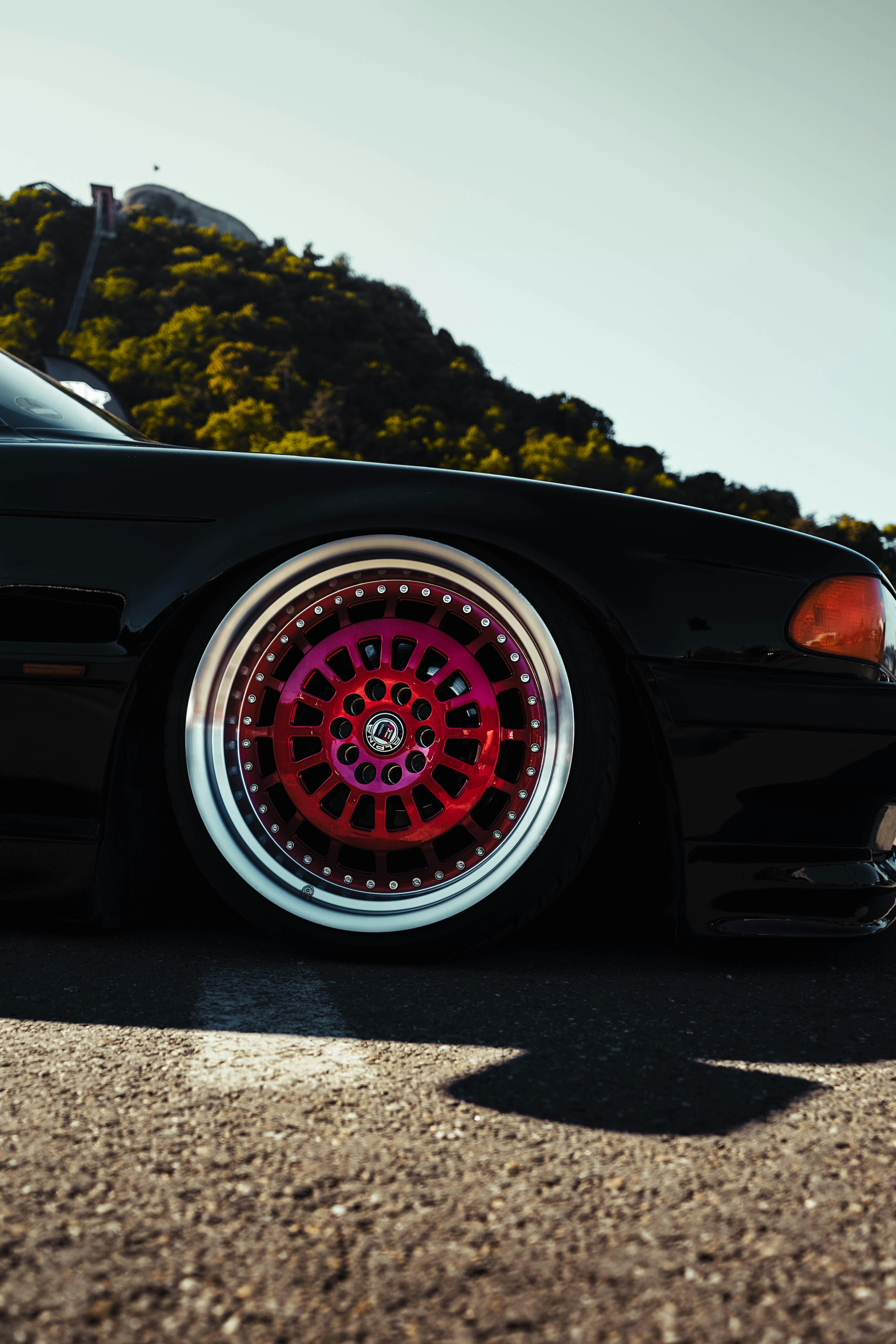 Crimson Mesh Wheel on a Low, Glossy Black Ride