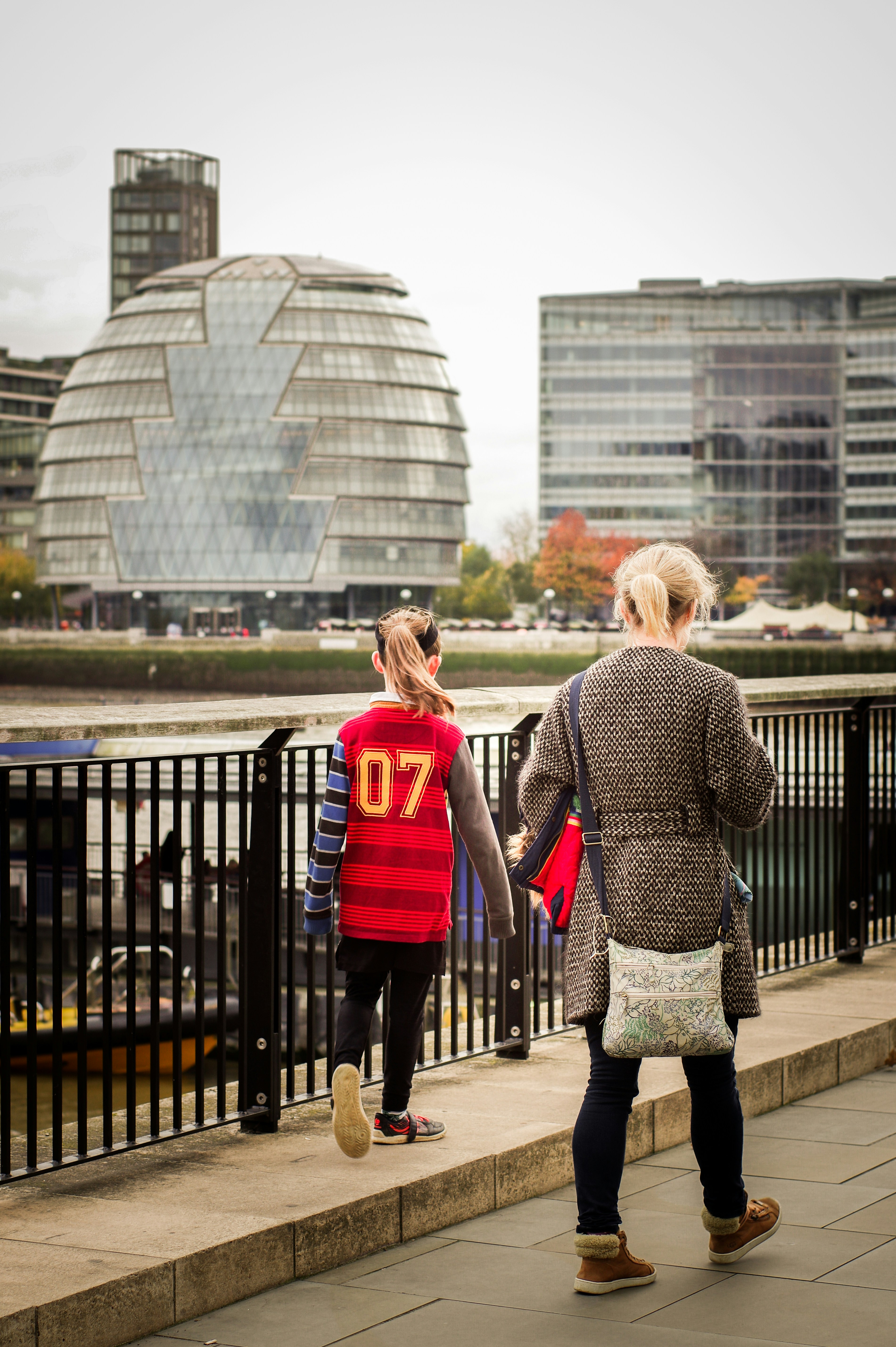 a couple of people walking down a sidewalk