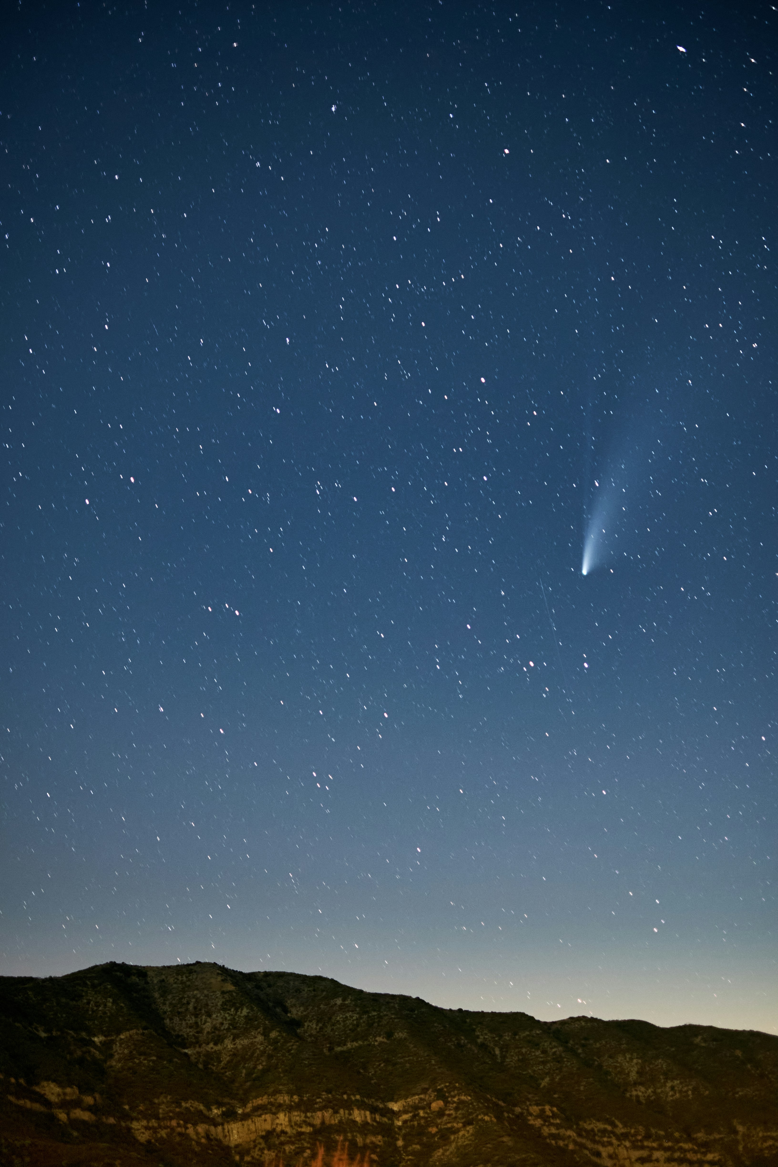 A bright star shines in the sky above a mountain photo – Free Nature ...
