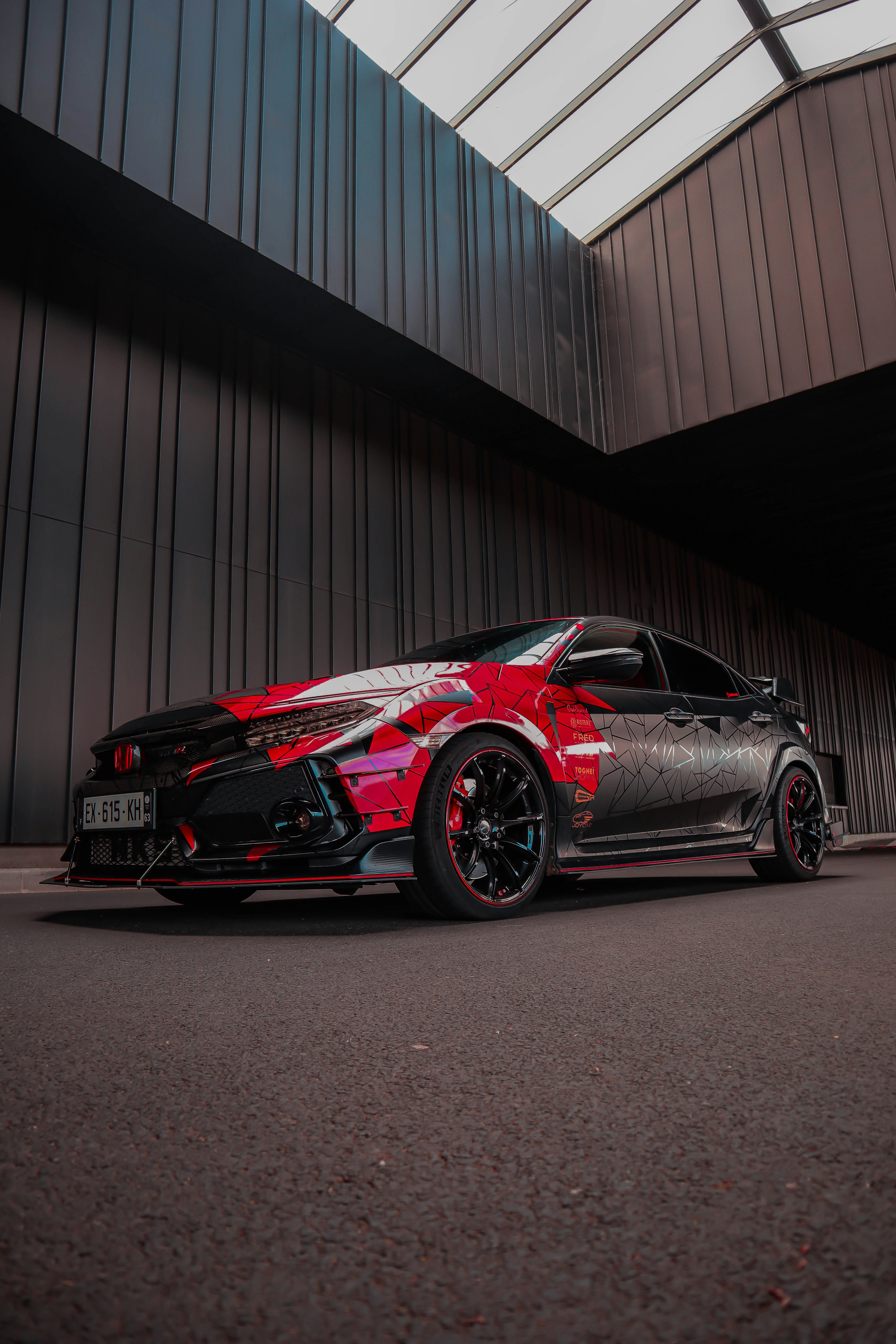 A silver and red sports car parked in front of a building photo – Free ...