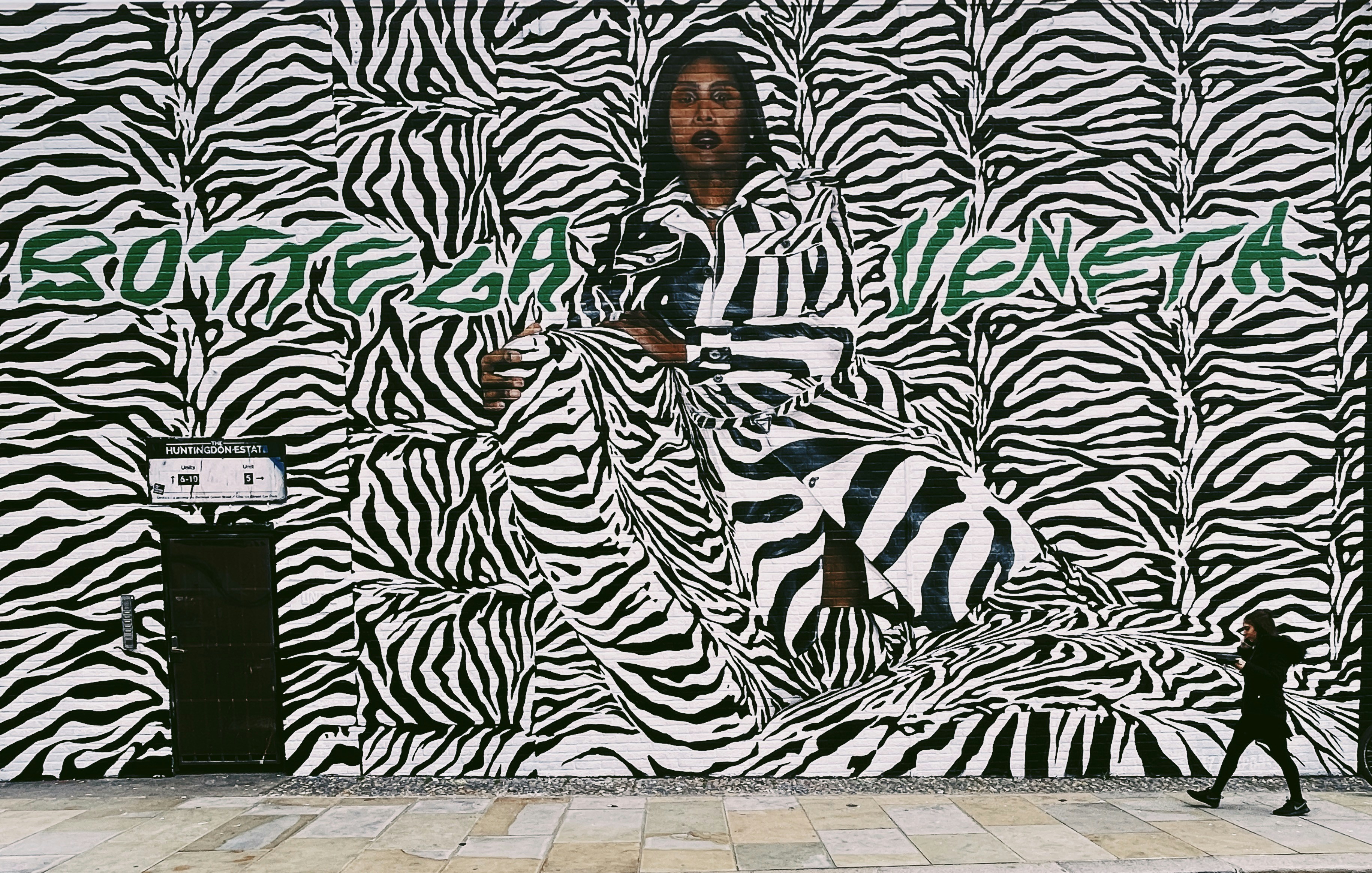 a man standing in front of a zebra print wall