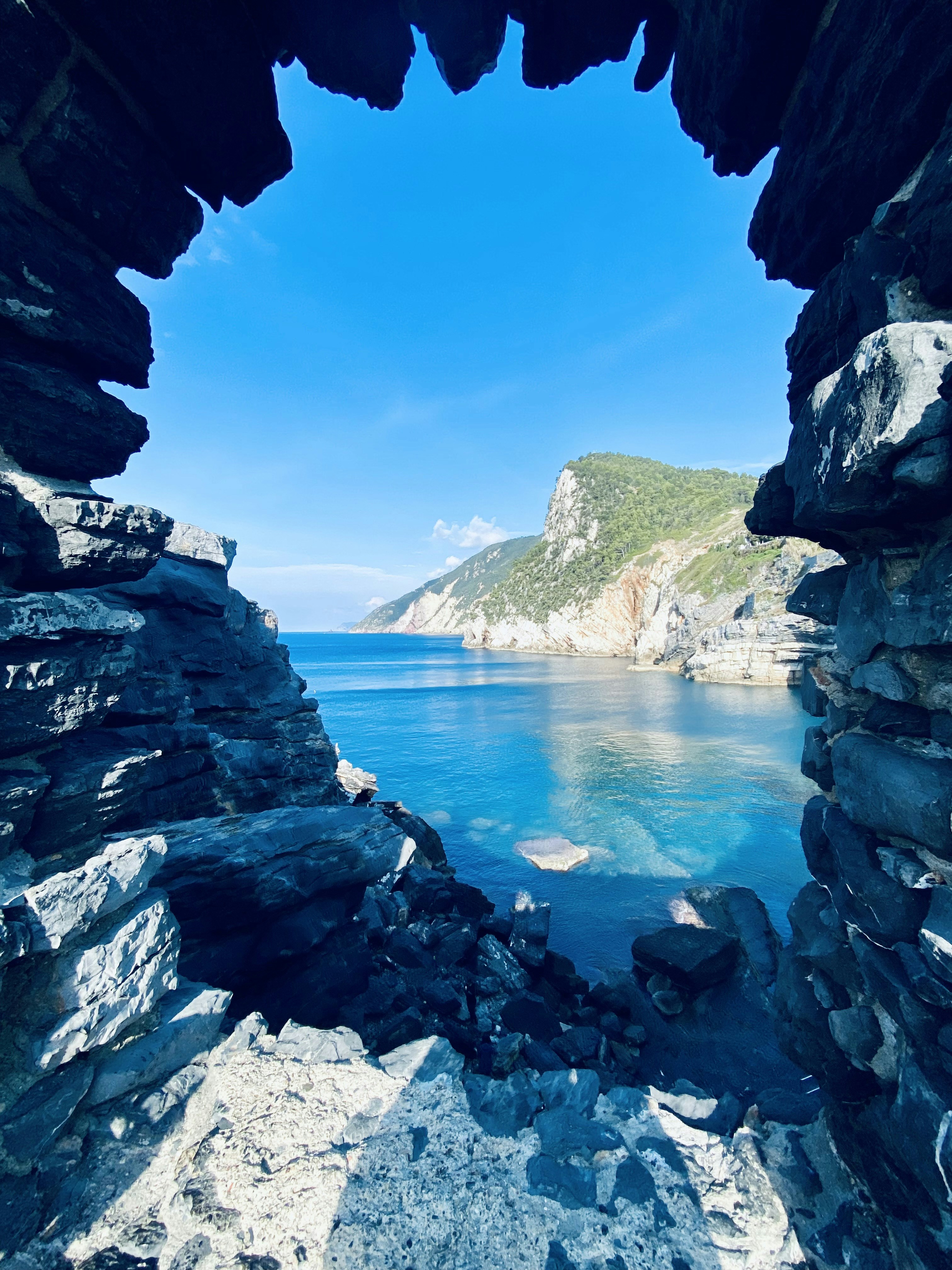 A view of a body of water from inside a cave photo – Free Porto venere ...