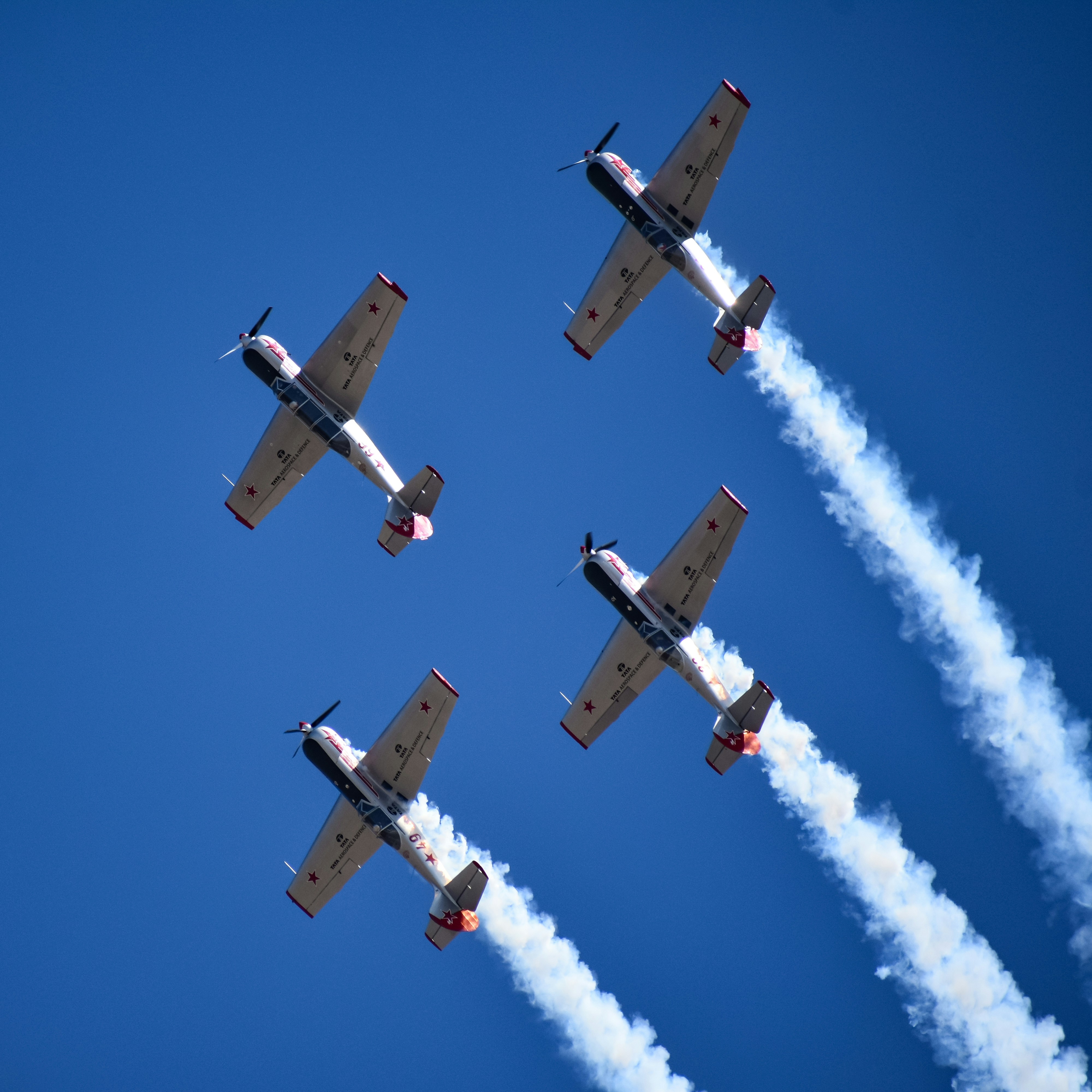 A group of airplanes flying through a blue sky photo – Free India Image ...