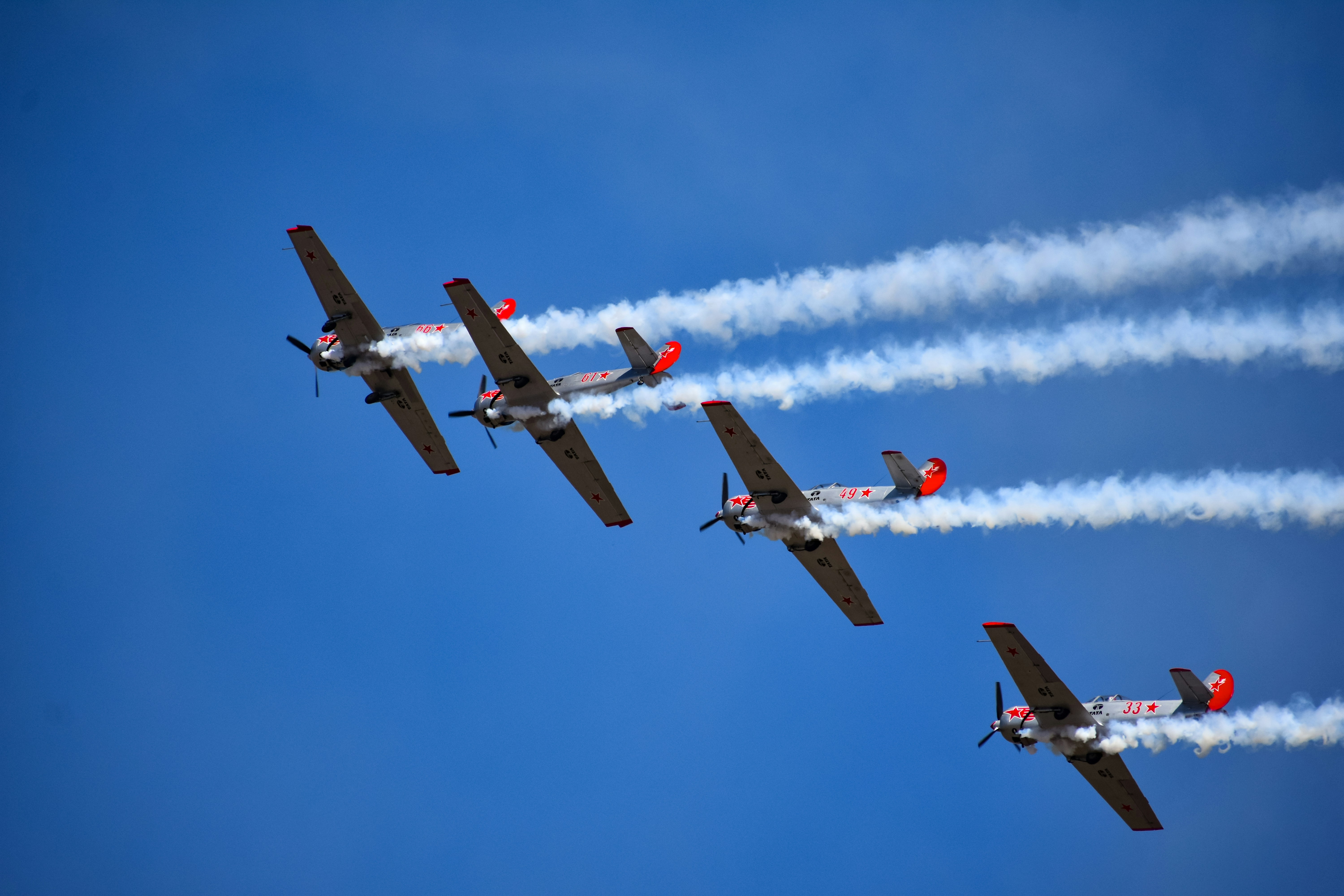 A group of airplanes flying through a blue sky photo – Free India Image ...