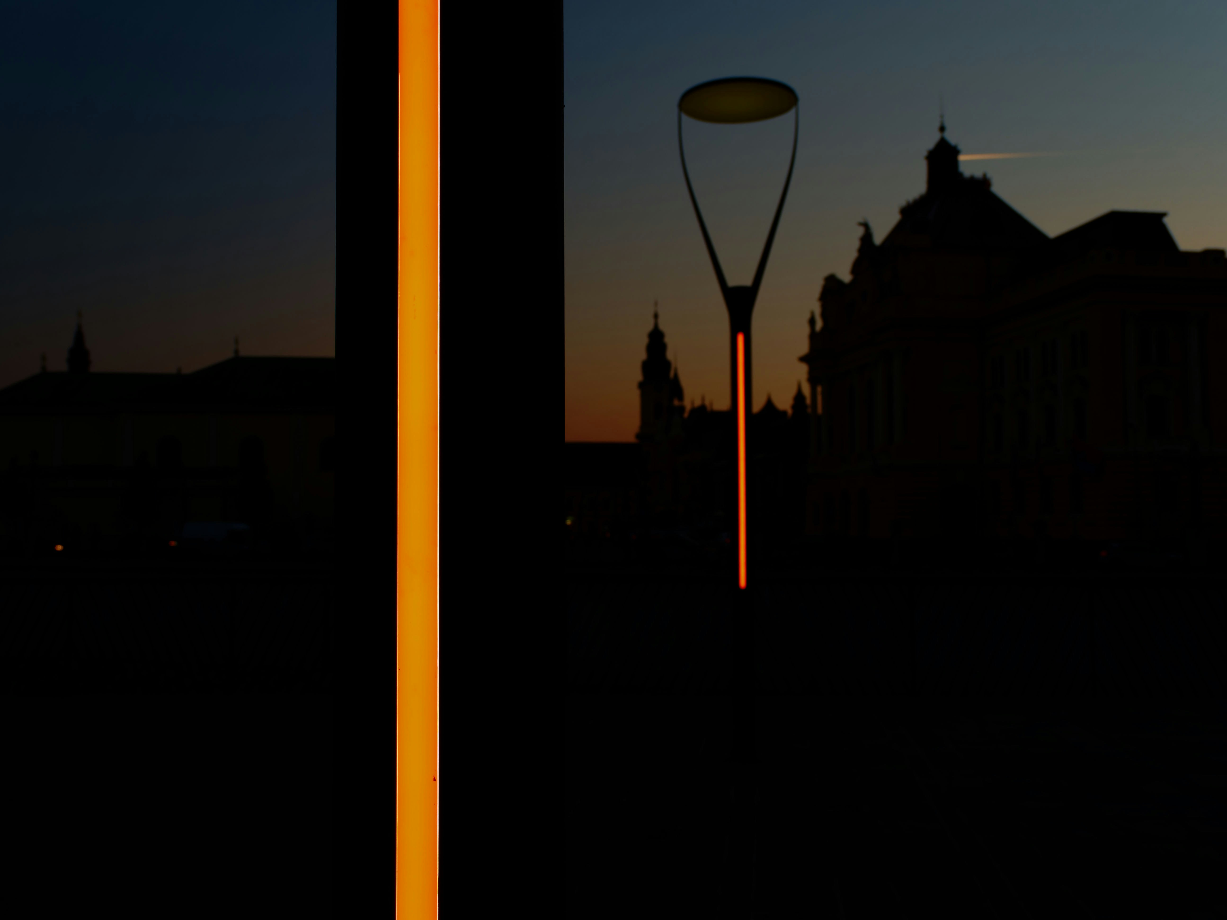 Ember-Threaded Dusk: A lone streetlamp frames a silent city