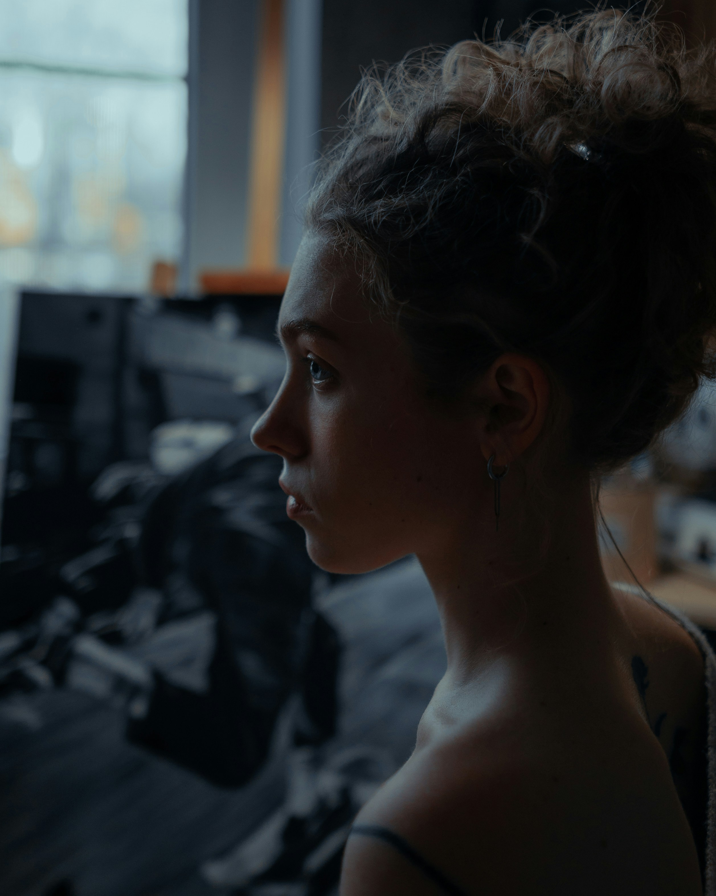 A woman in a dark room staring at something photo – Free Portrait Image ...