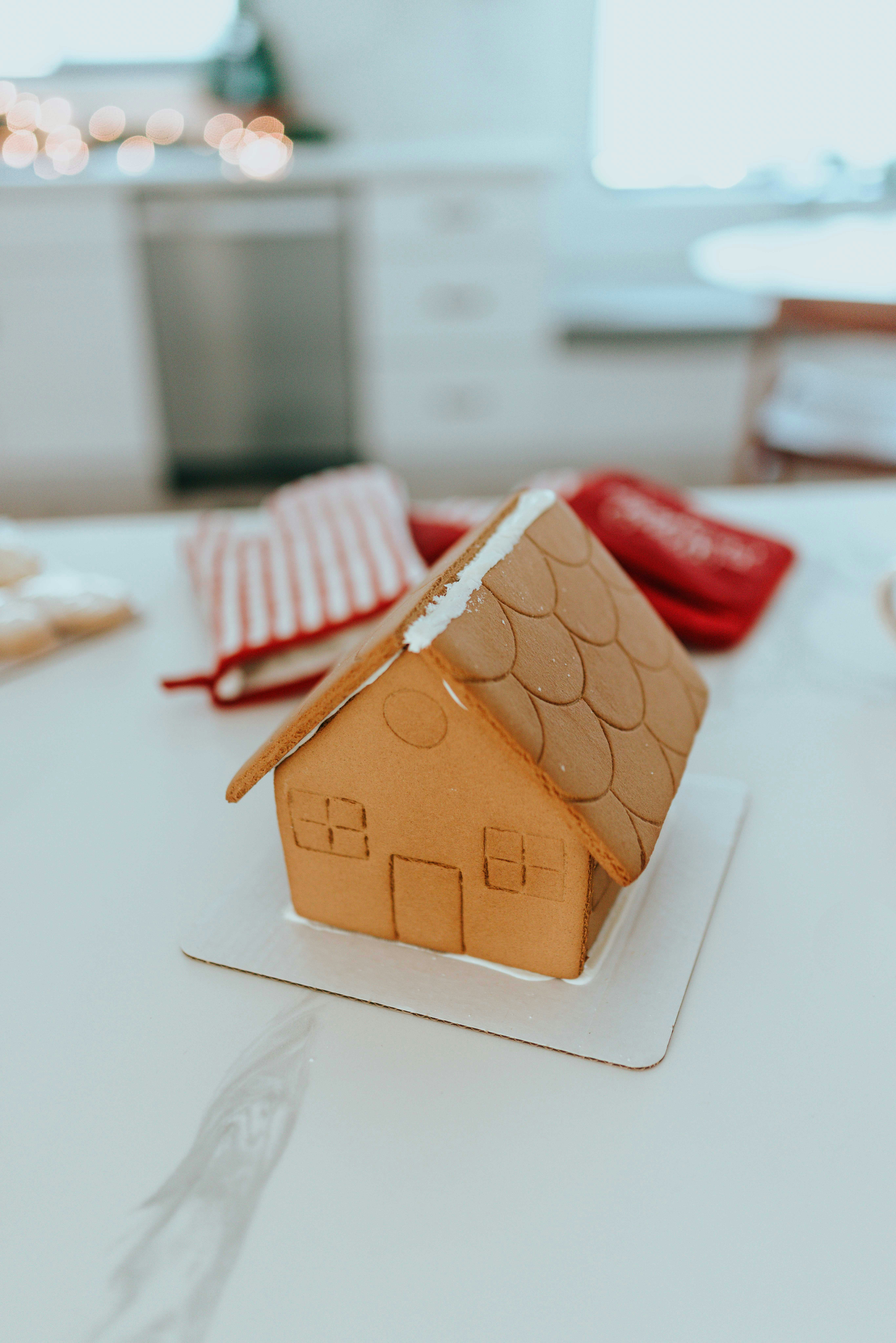 Tiny Gingerbread Cottage Anchored on a Gleaming Kitchen Table