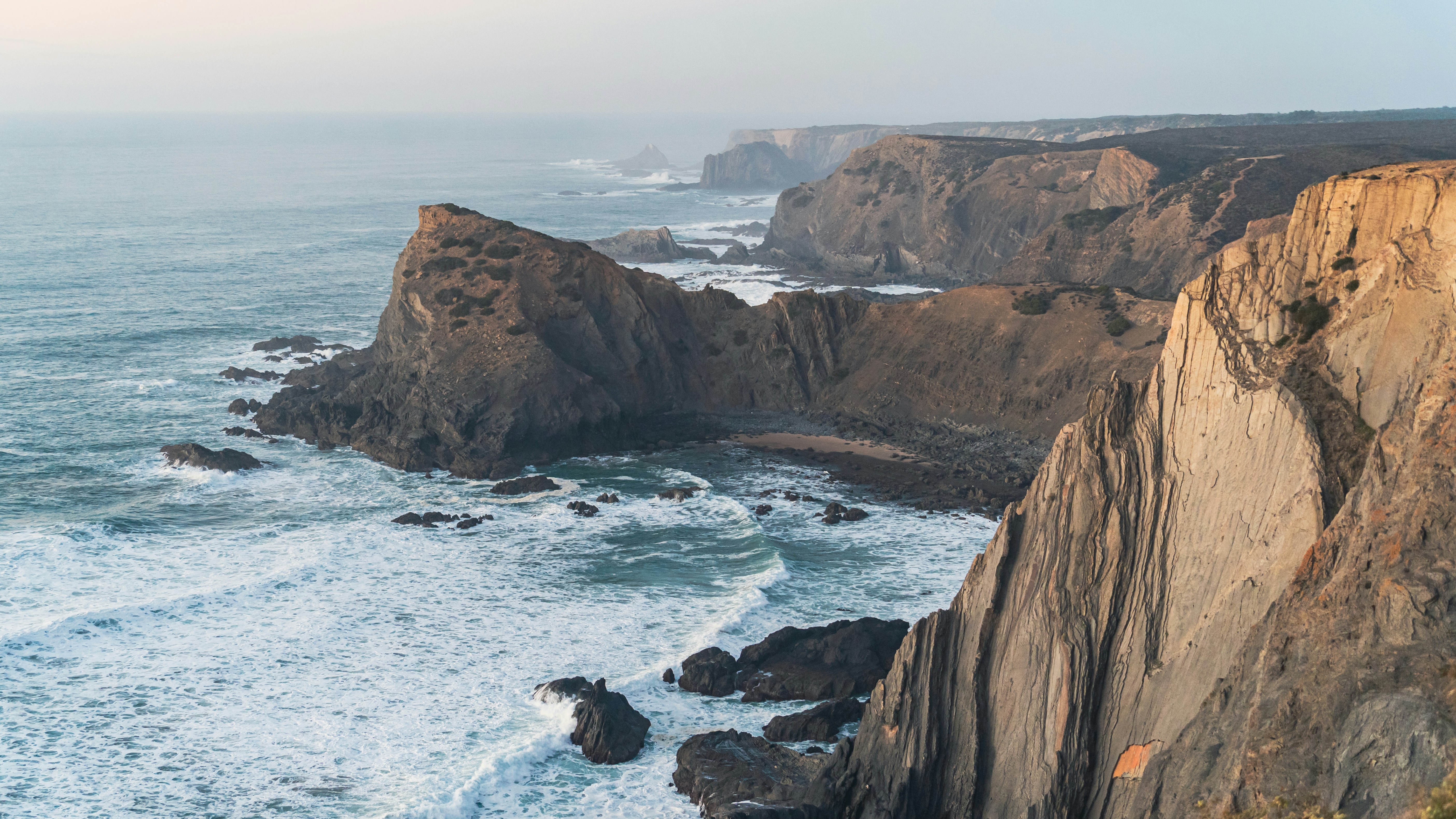 A view of the ocean from the top of a cliff photo – Free Cliff Image on ...