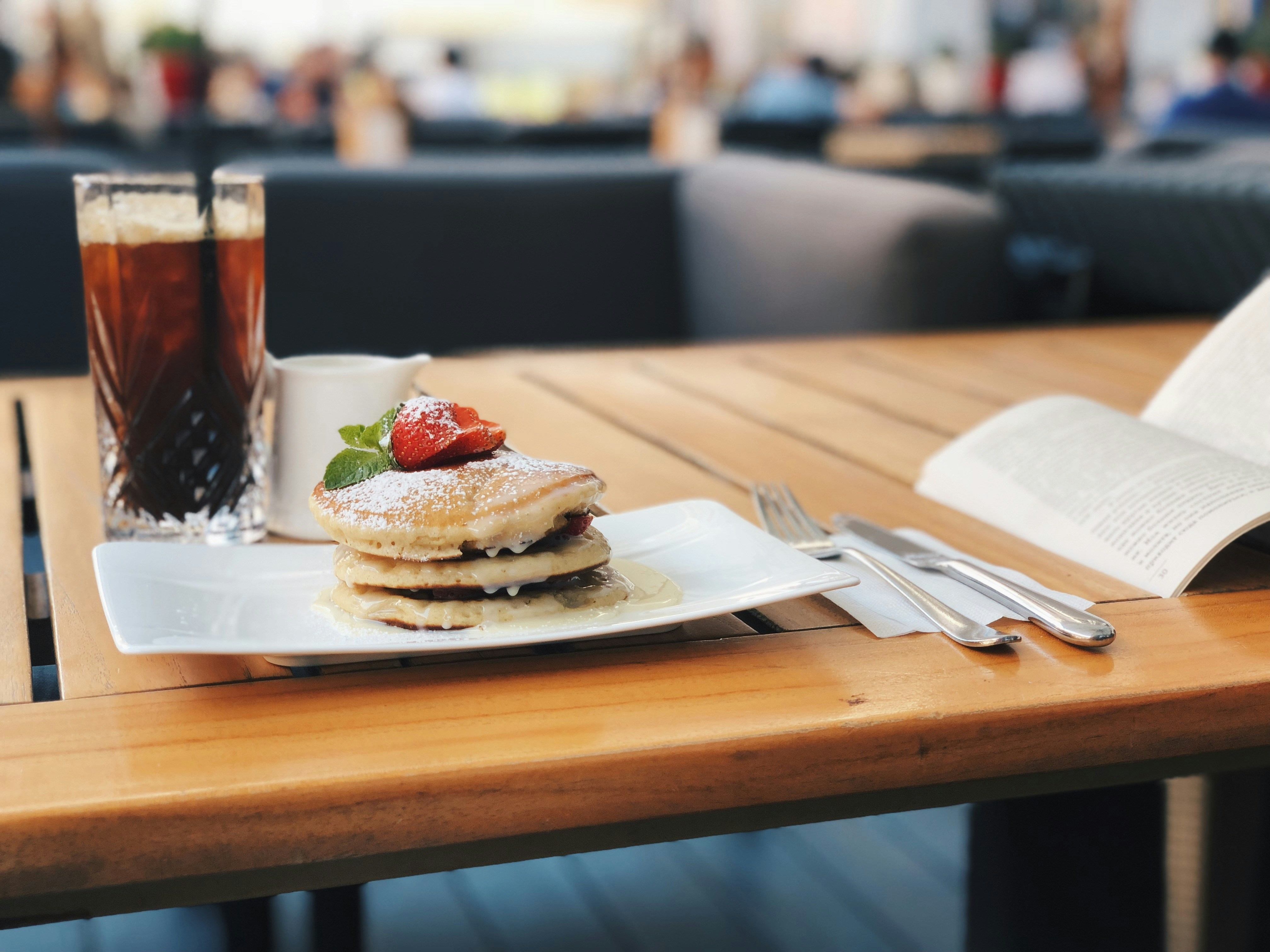 A plate of pancakes and a glass of tea on a table photo – Free Coffee ...