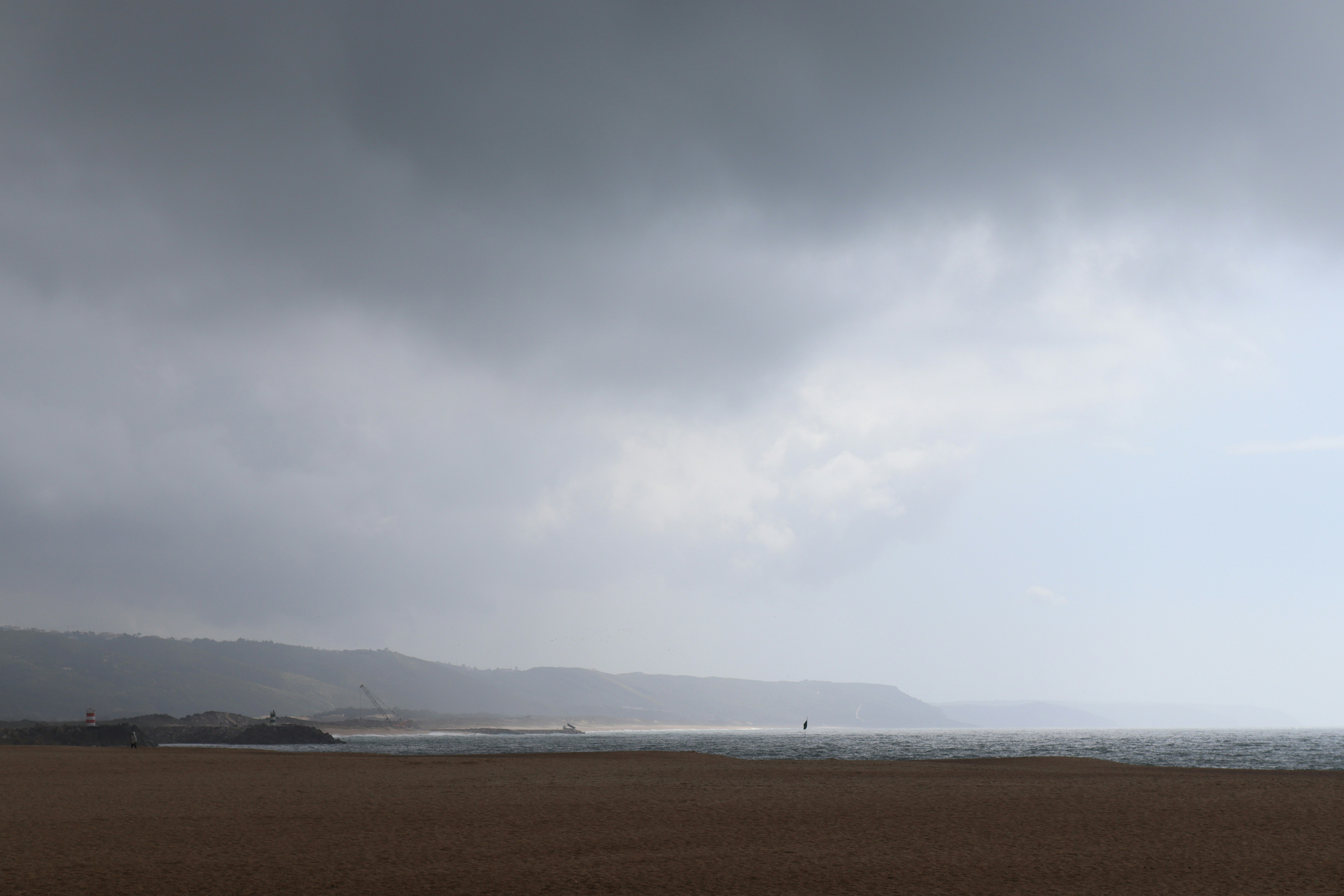 a large body of water under a cloudy sky