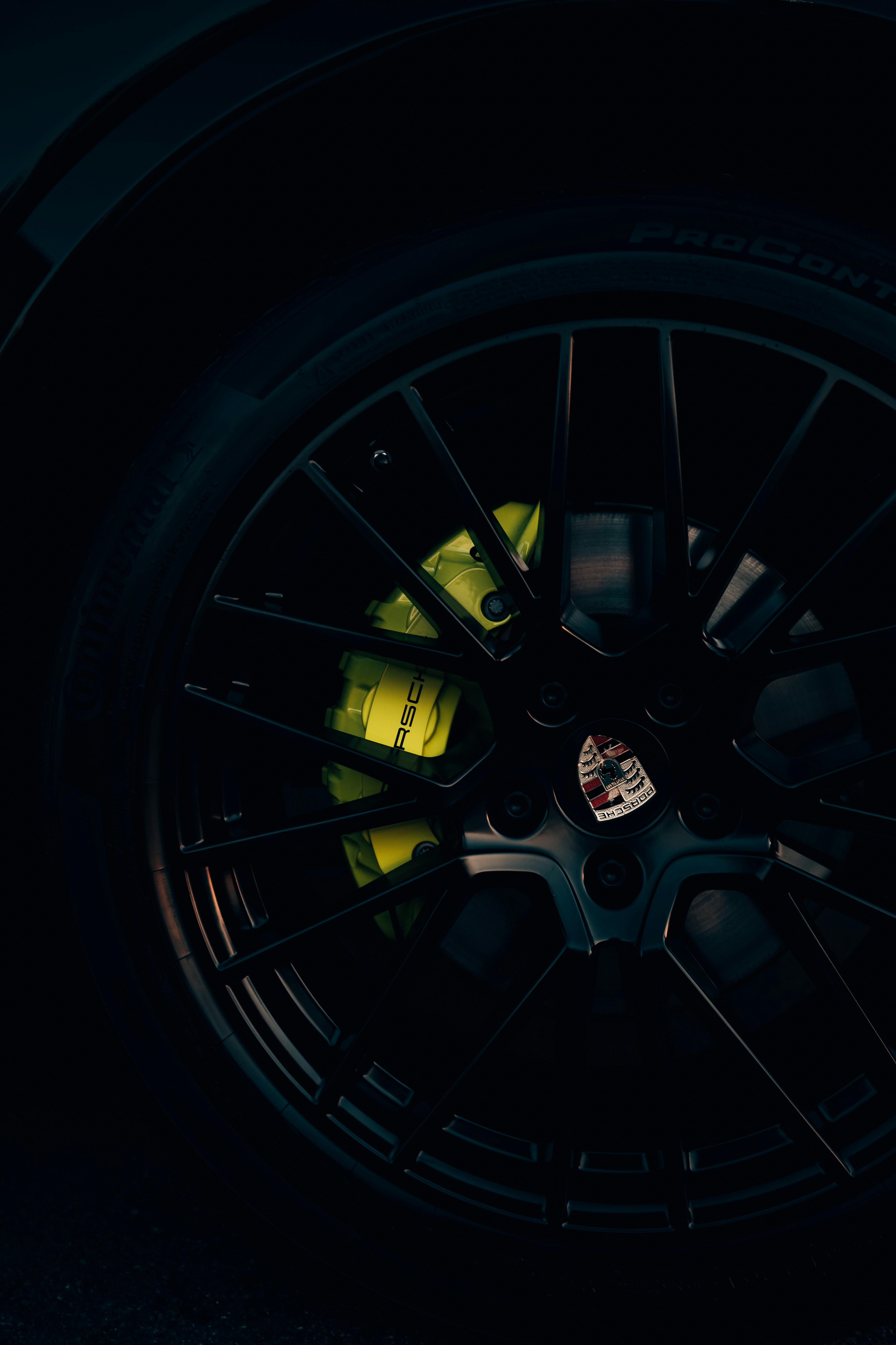 Neon Lime Calipers Pierce the Velvet Shadow of a Porsche Wheel