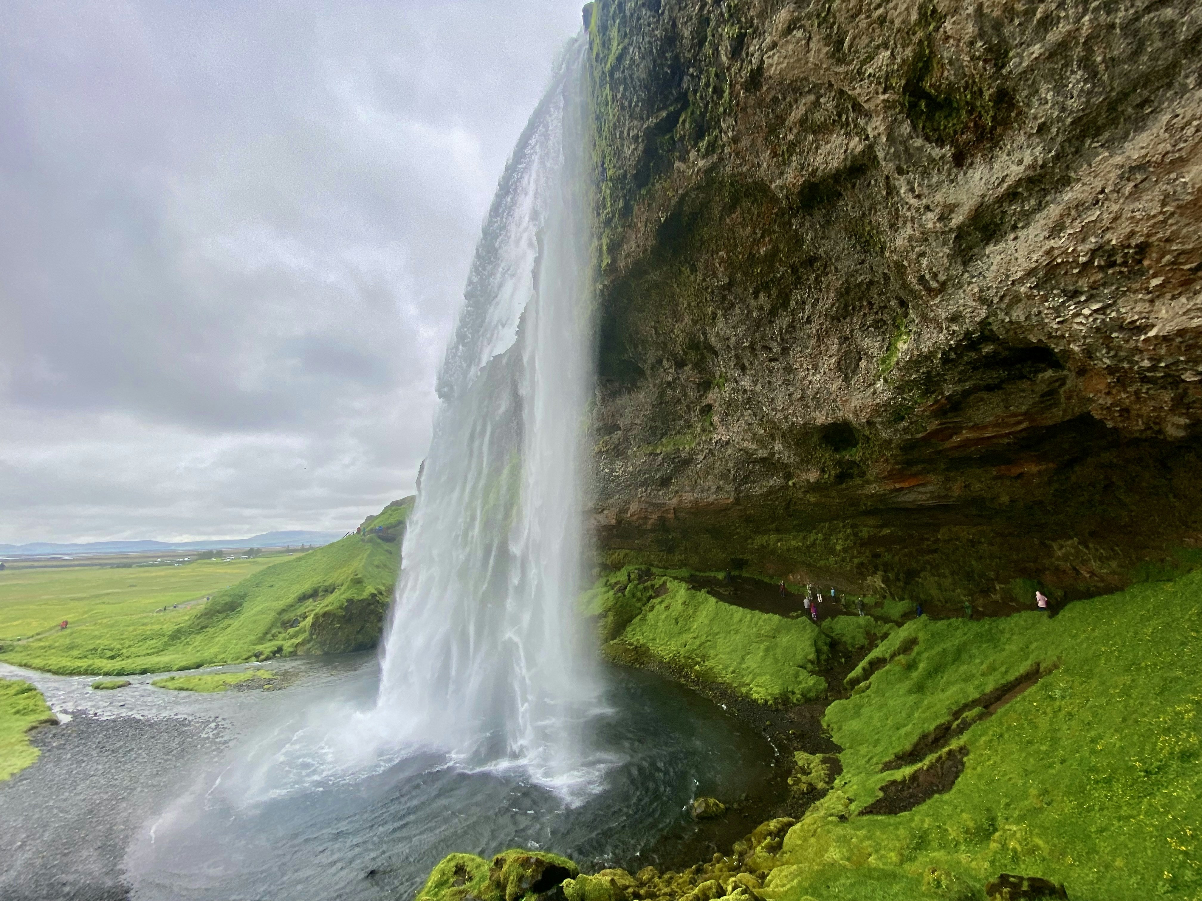 Verdant Curtain: Moss-Covered Cliffside Waterfall